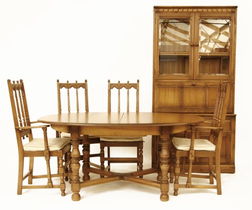 Lot 869 - A modern Ercol elm dining suite