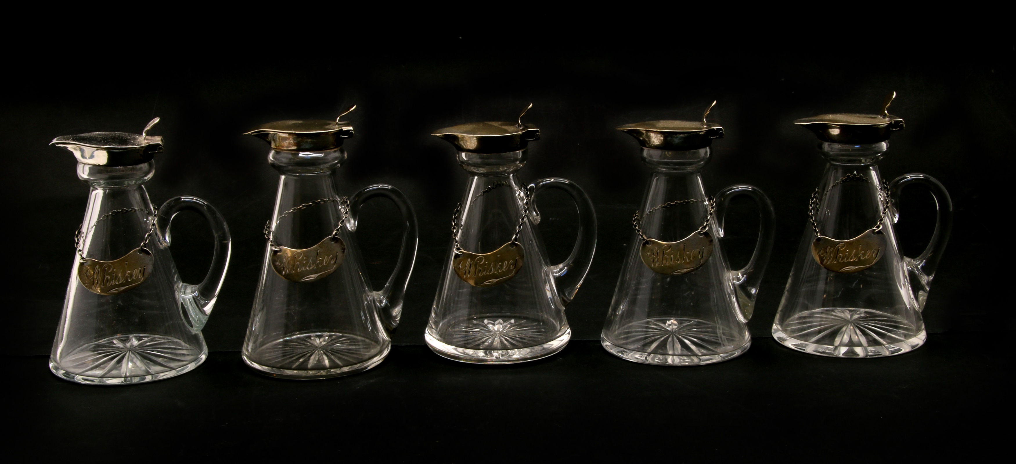 Lot 18 - Five silver topped glass whisky tots