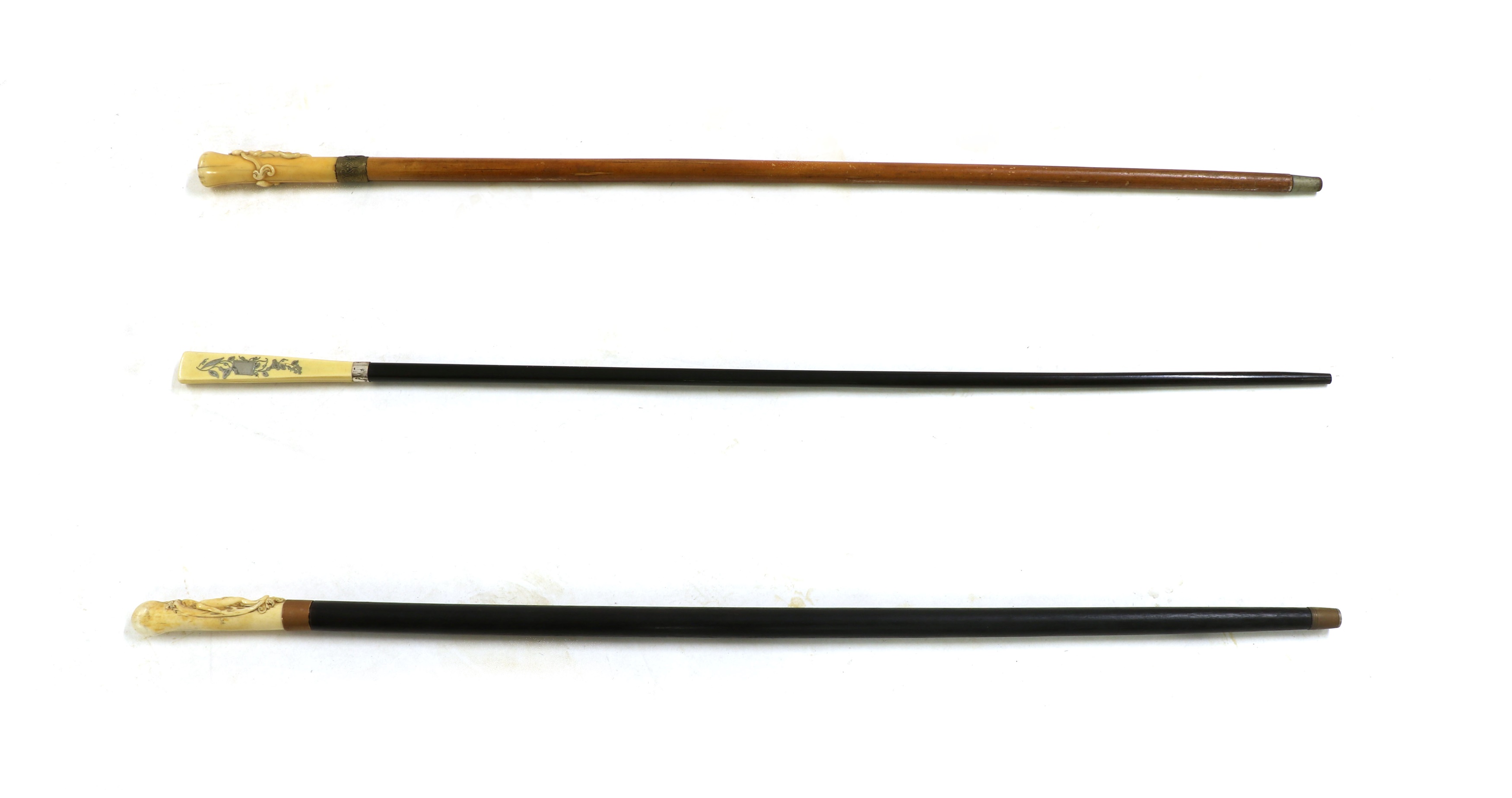 Lot 147 - A carved-ivory handled walking cane,