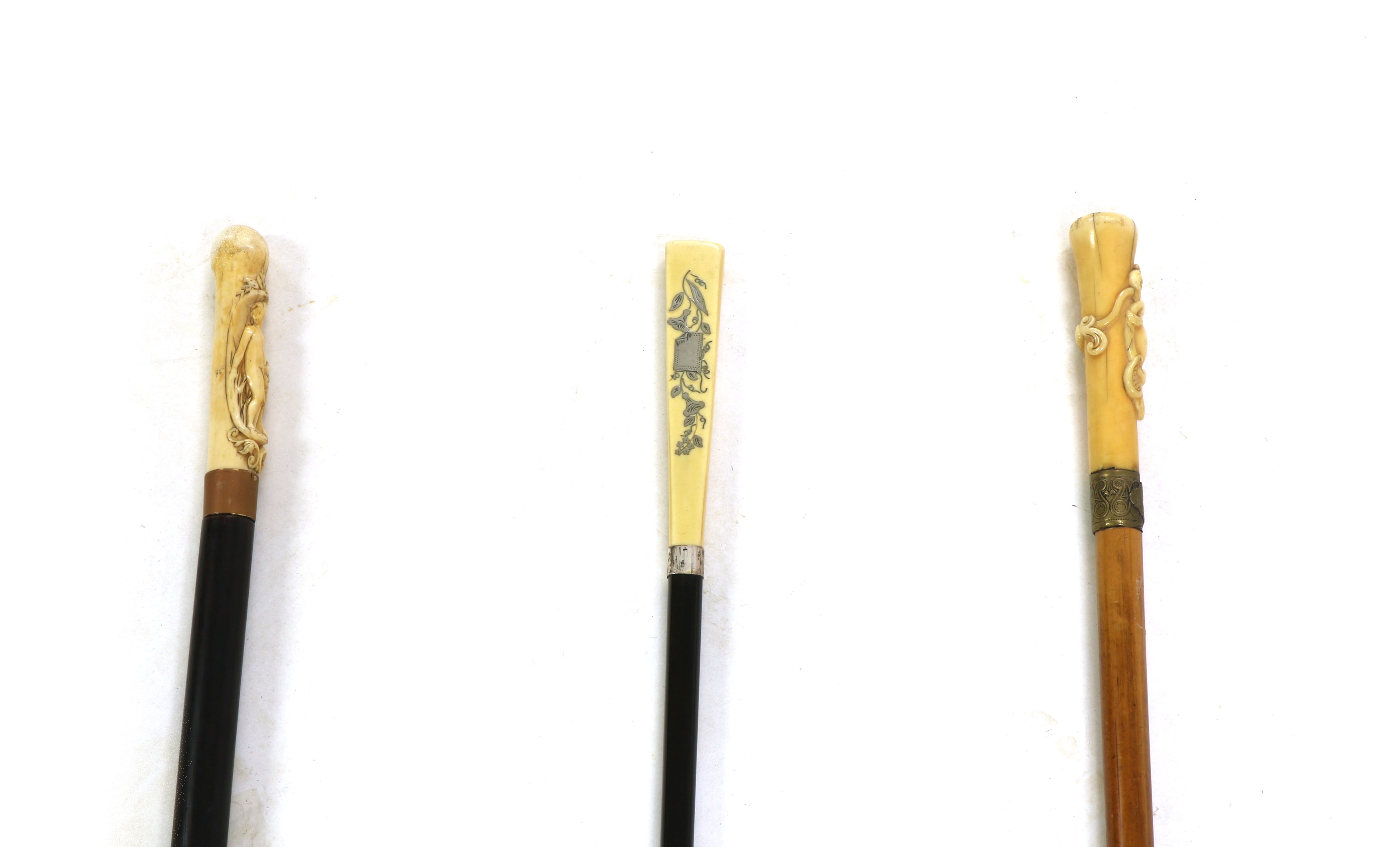 Lot 147 - A carved-ivory handled walking cane,