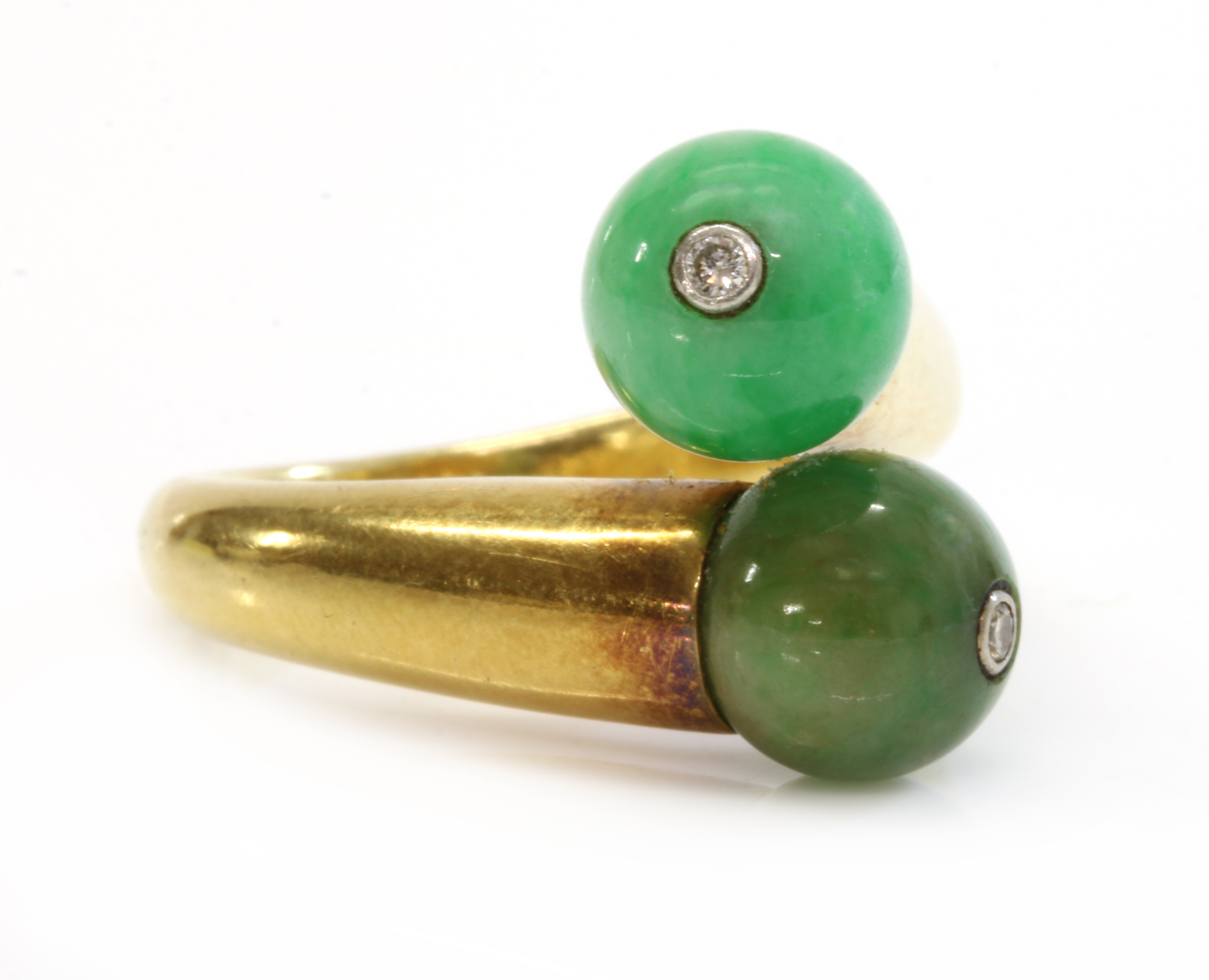 Lot 186 - A two stone jade bead and diamond crossover