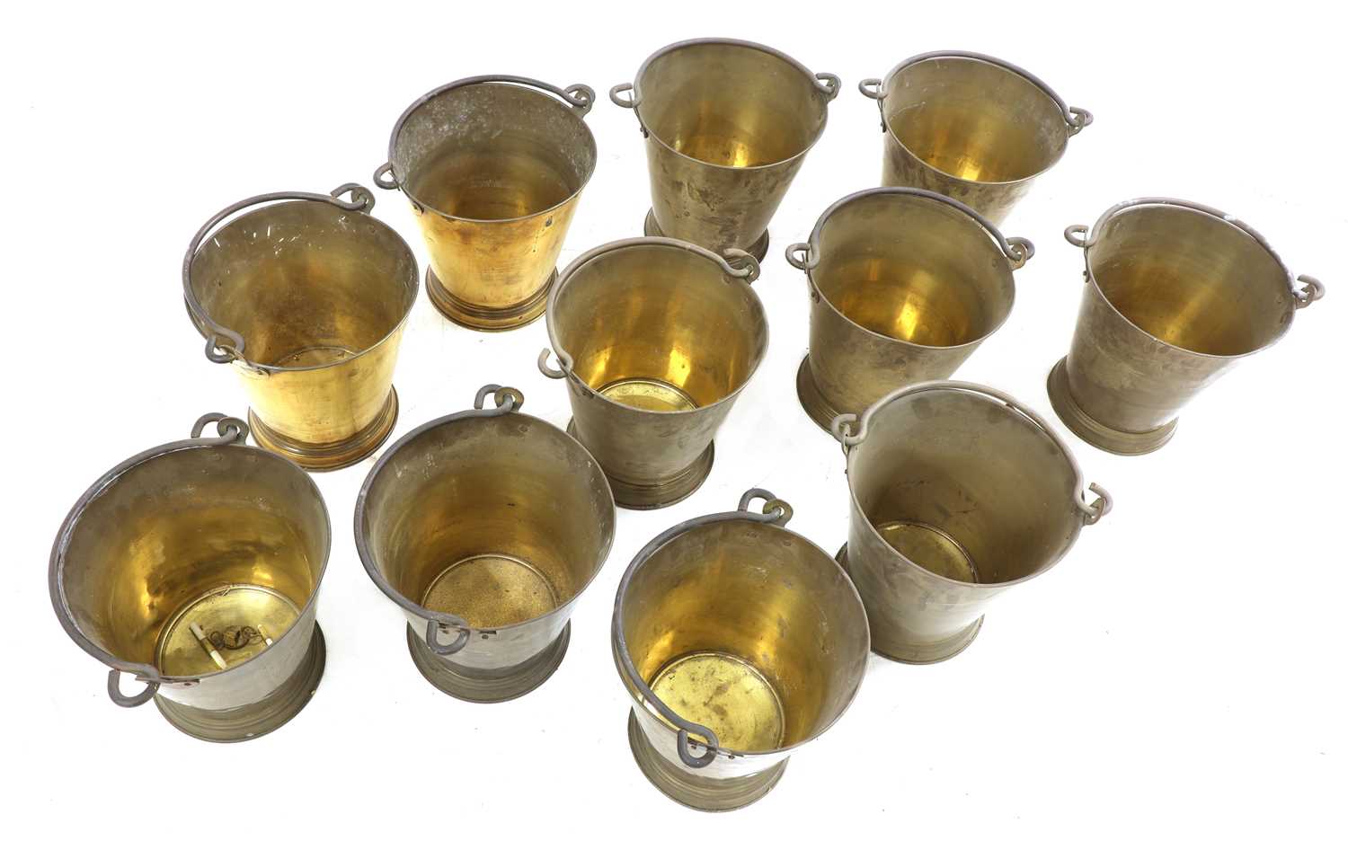 Lot 106 - A set of eleven brass buckets,