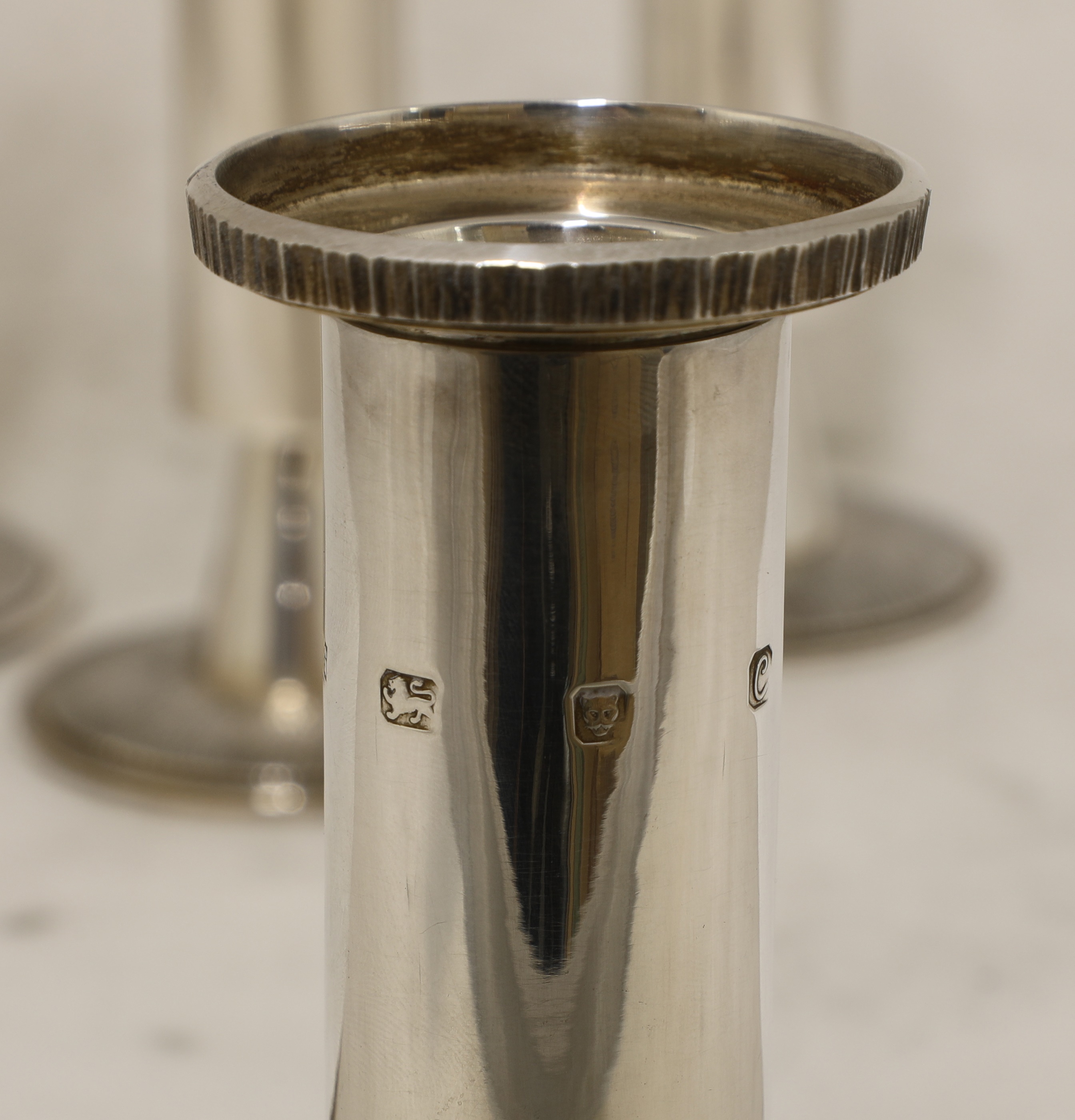 Lot 654 - A set of four silver candlesticks,