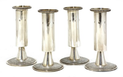 Lot 654 - A set of four silver candlesticks,