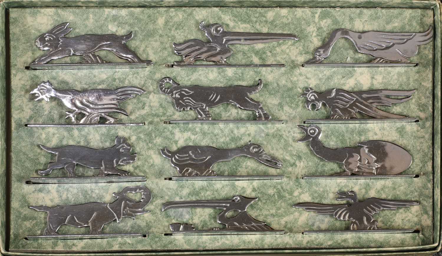 A set of twelve Art Deco silver-plated metal knife rests | Barnebys