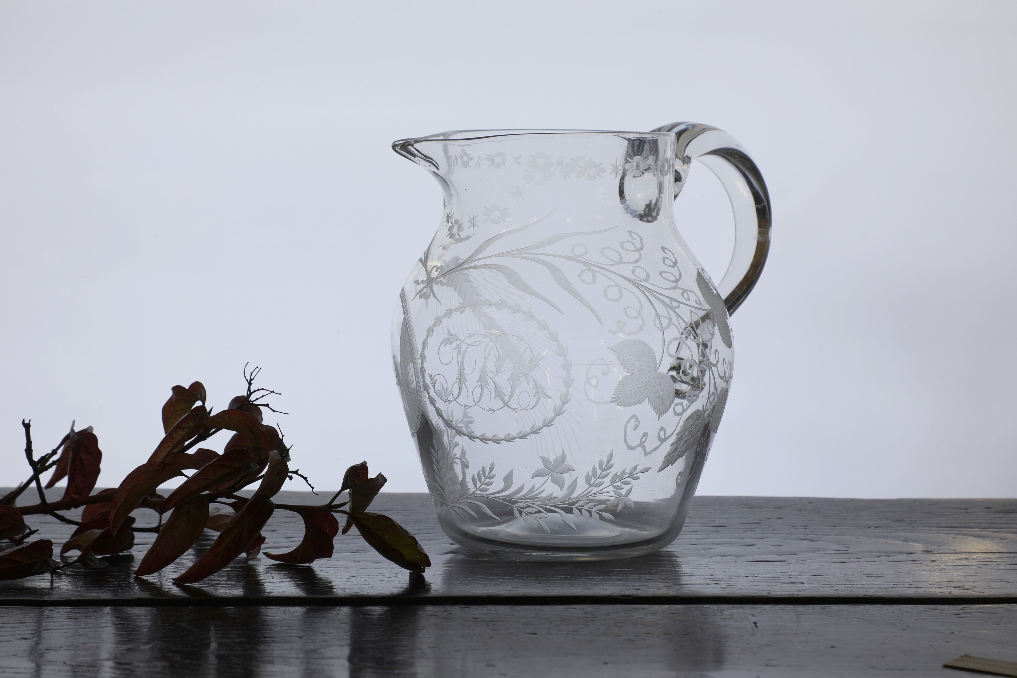 Lot 312 - An engraved glass ale jug,