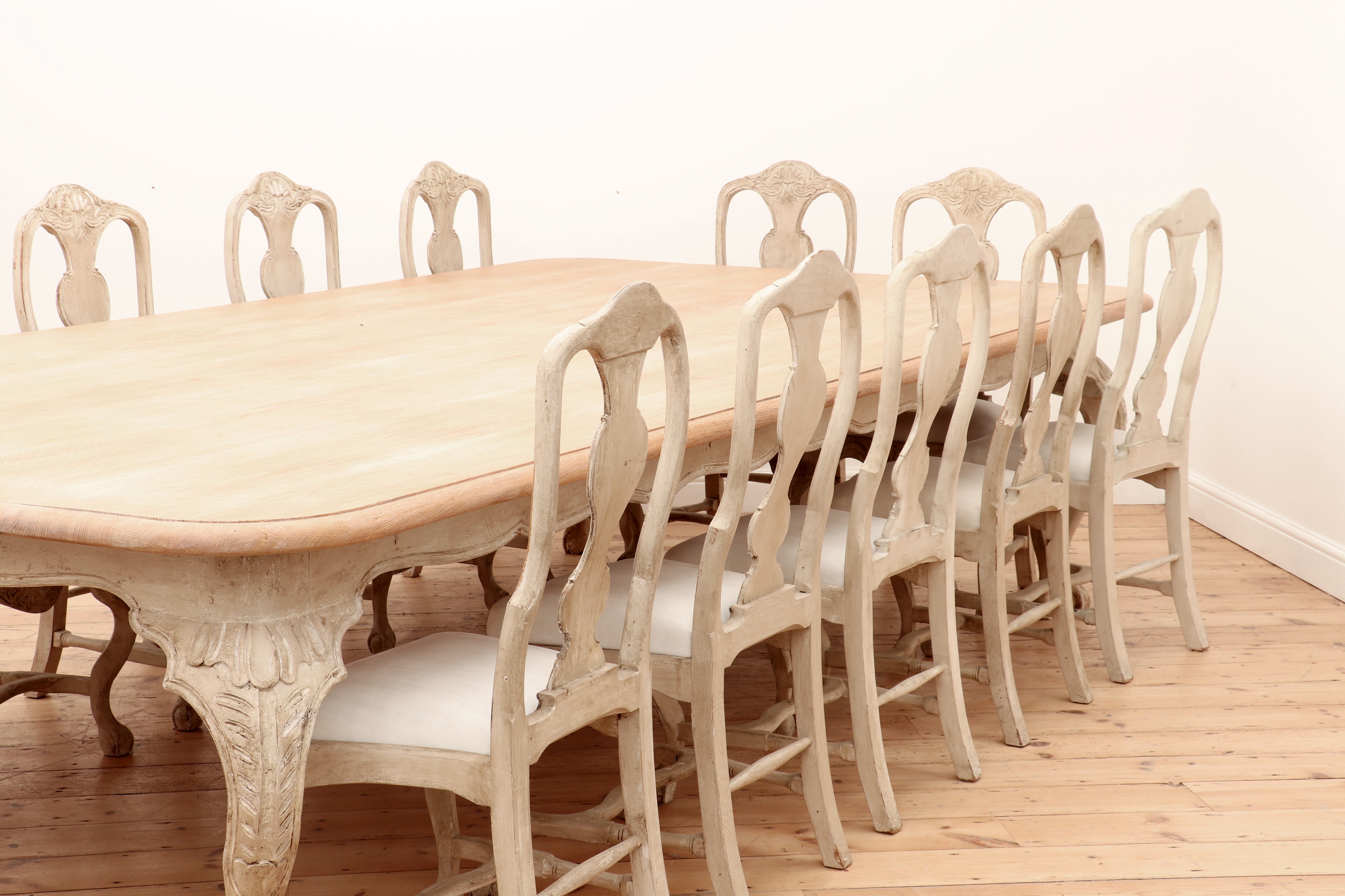 Lot 24 - A large limed oak dining table,