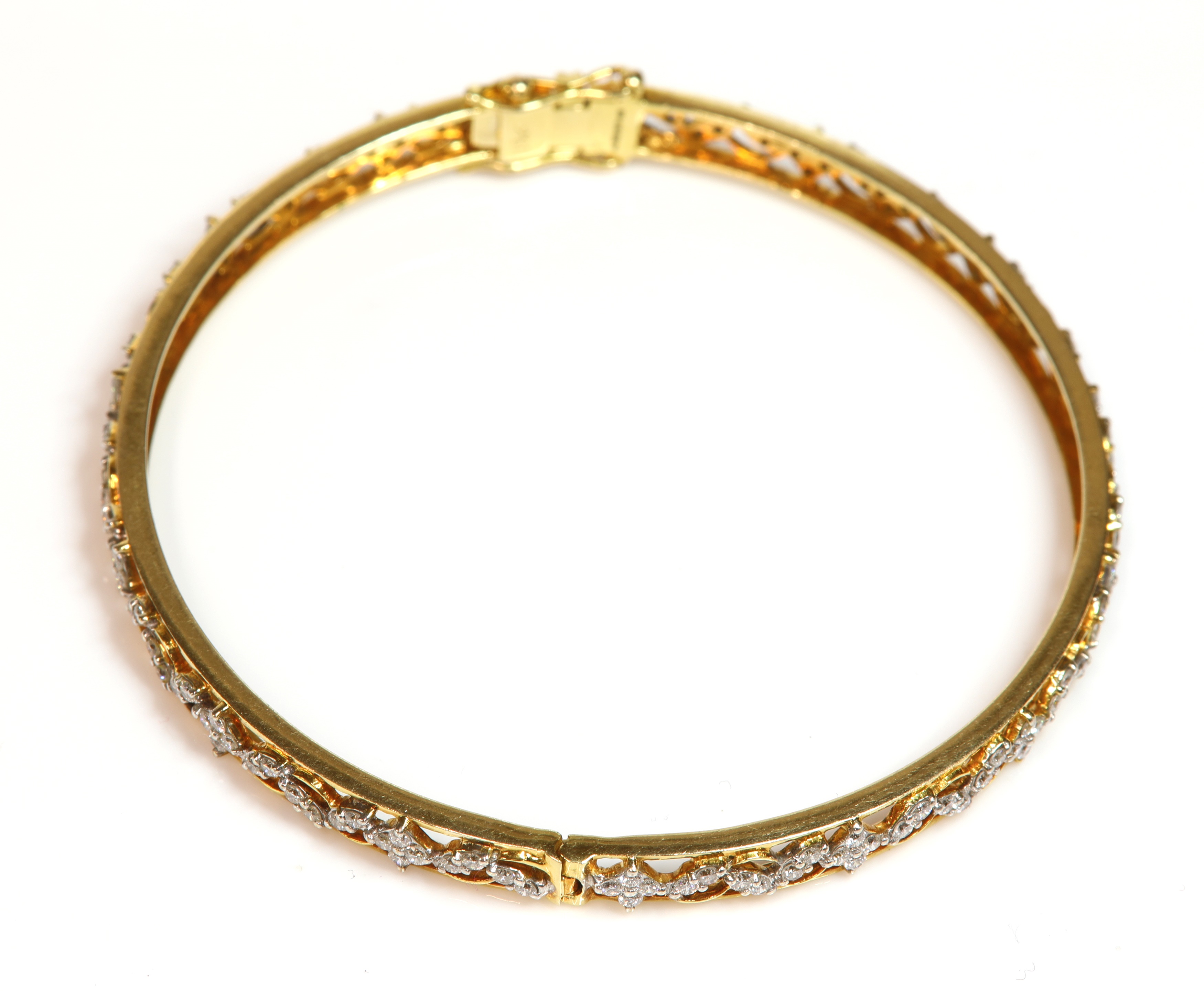 Lot 333 - An 18ct gold diamond set hinged bangle,