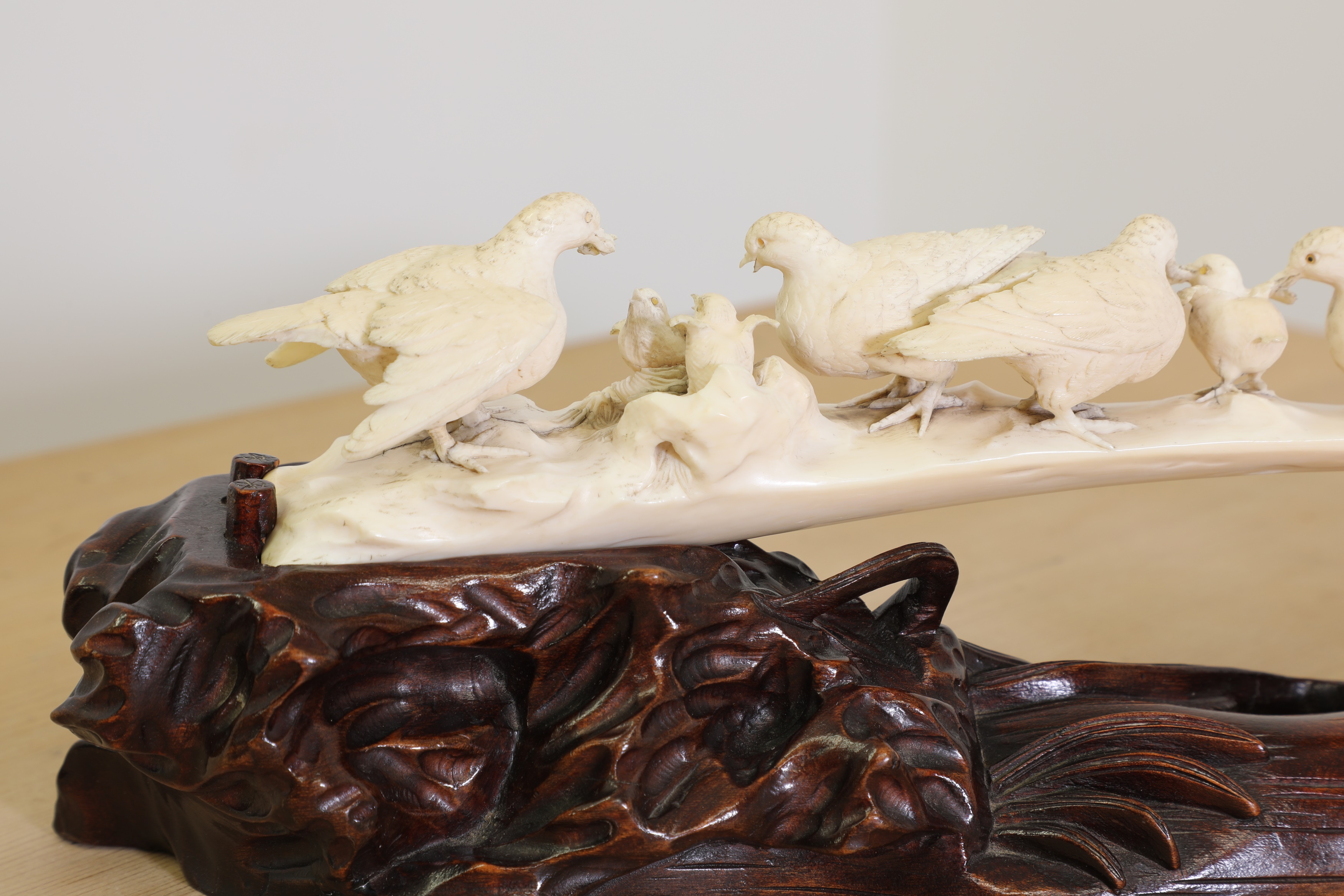 Lot 180 - A Japanese carved ivory dove bridge group,