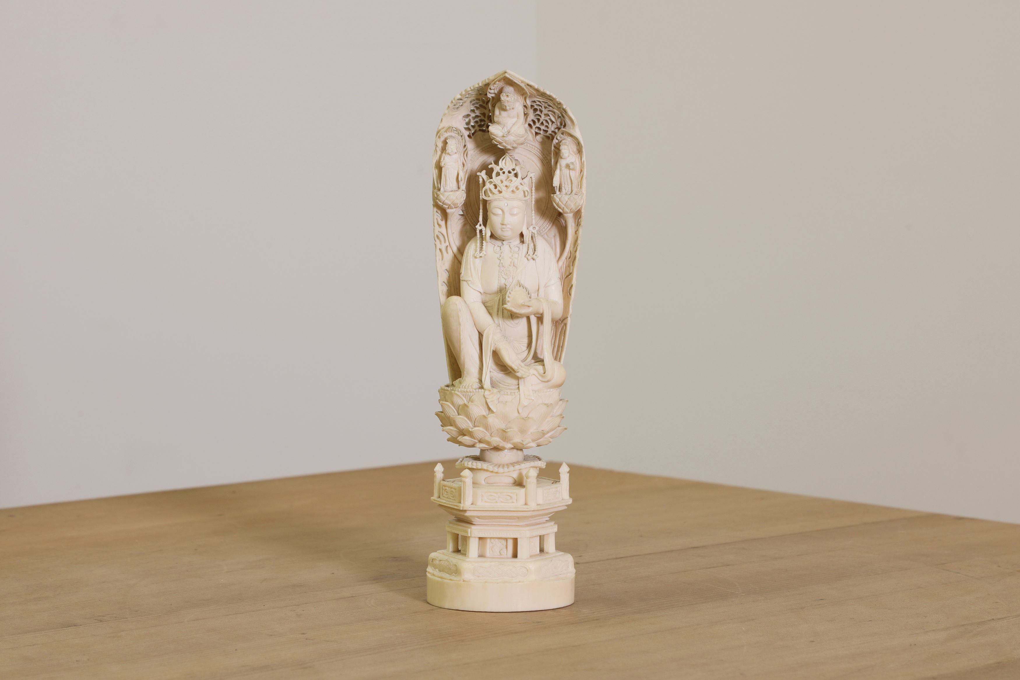 Lot 174 - A Japanese solid carved ivory figure of