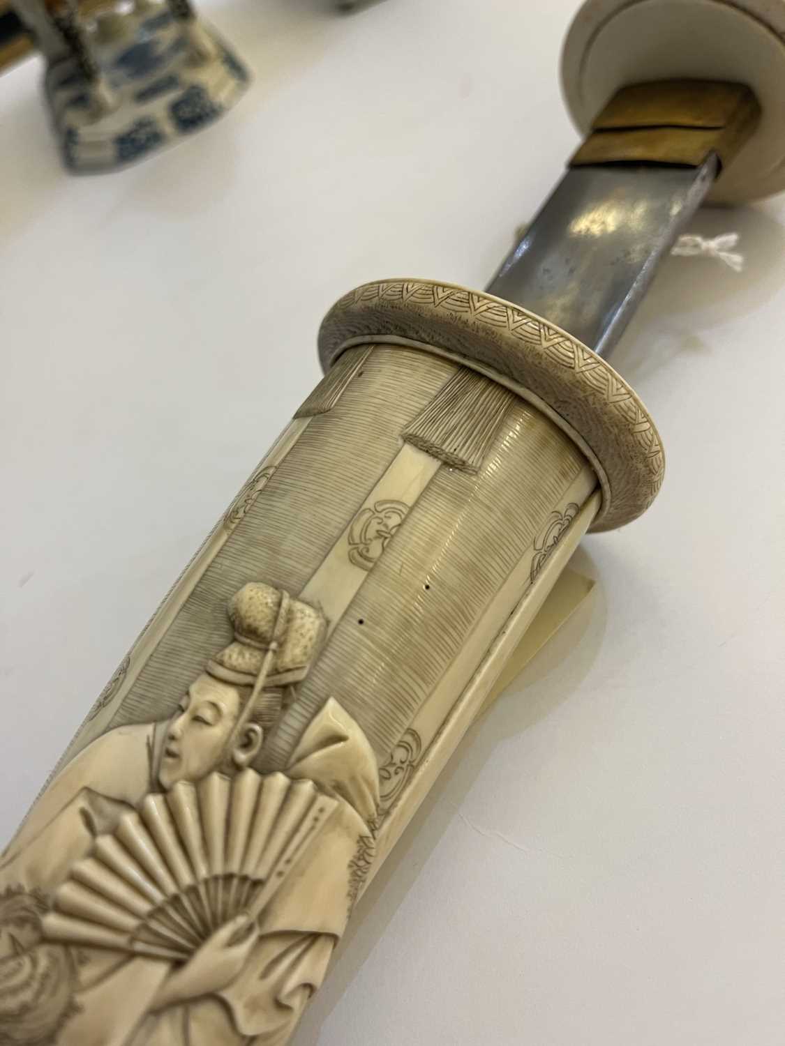 Lot 181 - A Japanese carved ivory short sword,