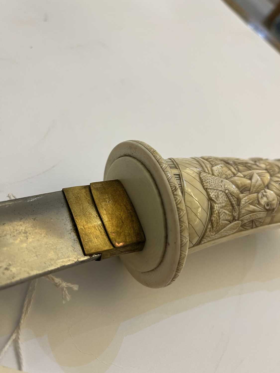 Lot 181 - A Japanese carved ivory short sword,
