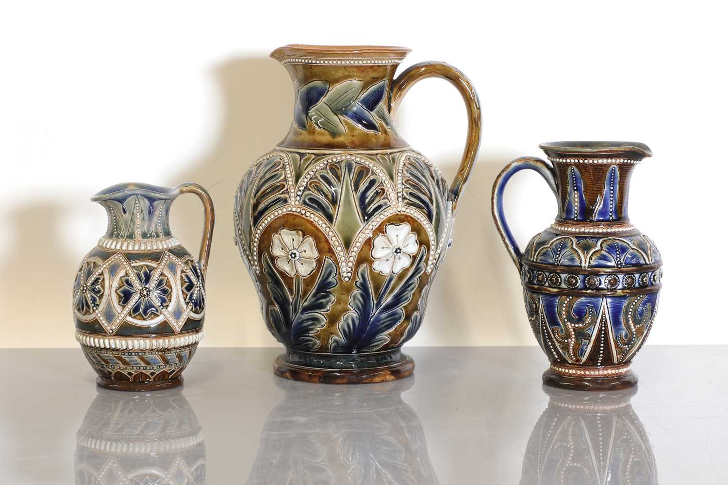 Lot 38 - Three Doulton Lambeth stoneware jugs,