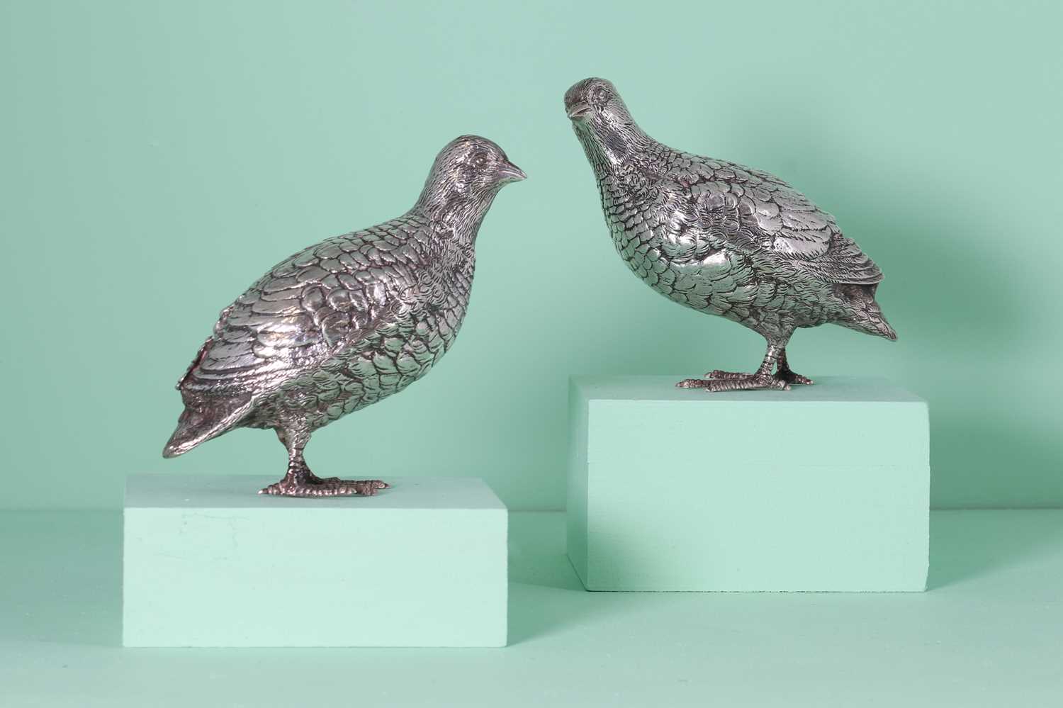 Lot 310 - A pair of silver models of partridges,