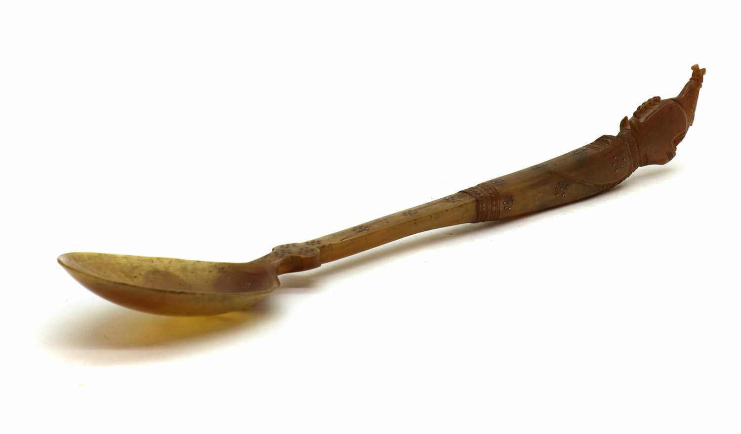 Lot 250 - A colonial Indonesian carved horn ladle,