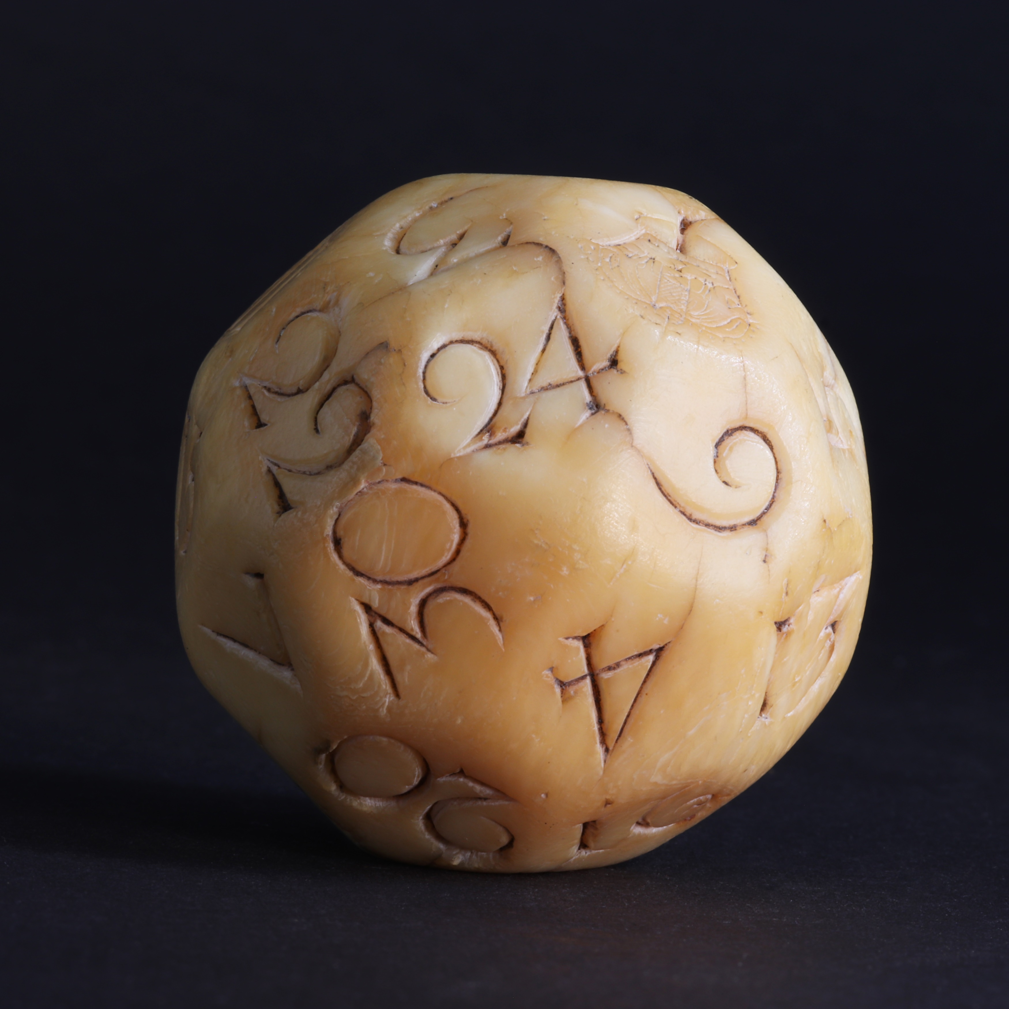 Lot 98 - A rare carved walrus ivory teetotum ball,