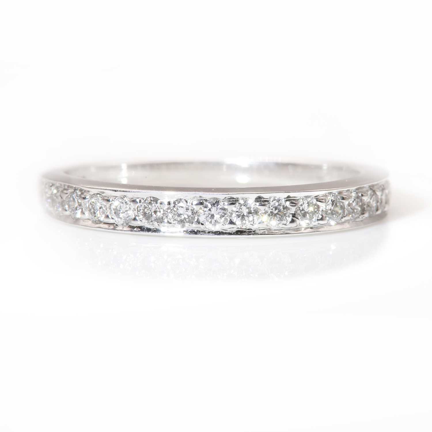 Lot 366 - An 18ct white gold diamond set half eternity