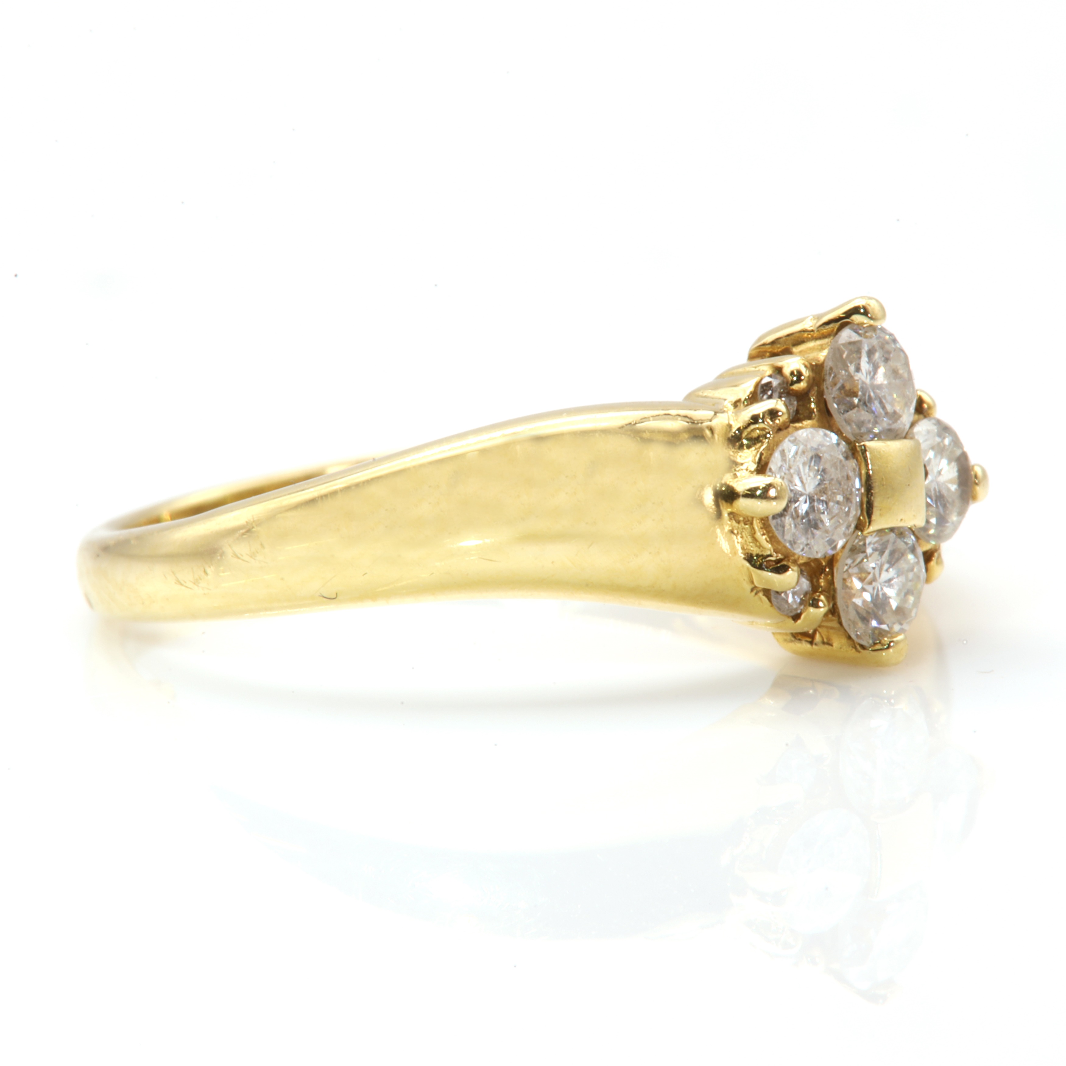 Lot 51 - An 18ct gold four stone diamond quatrefoil