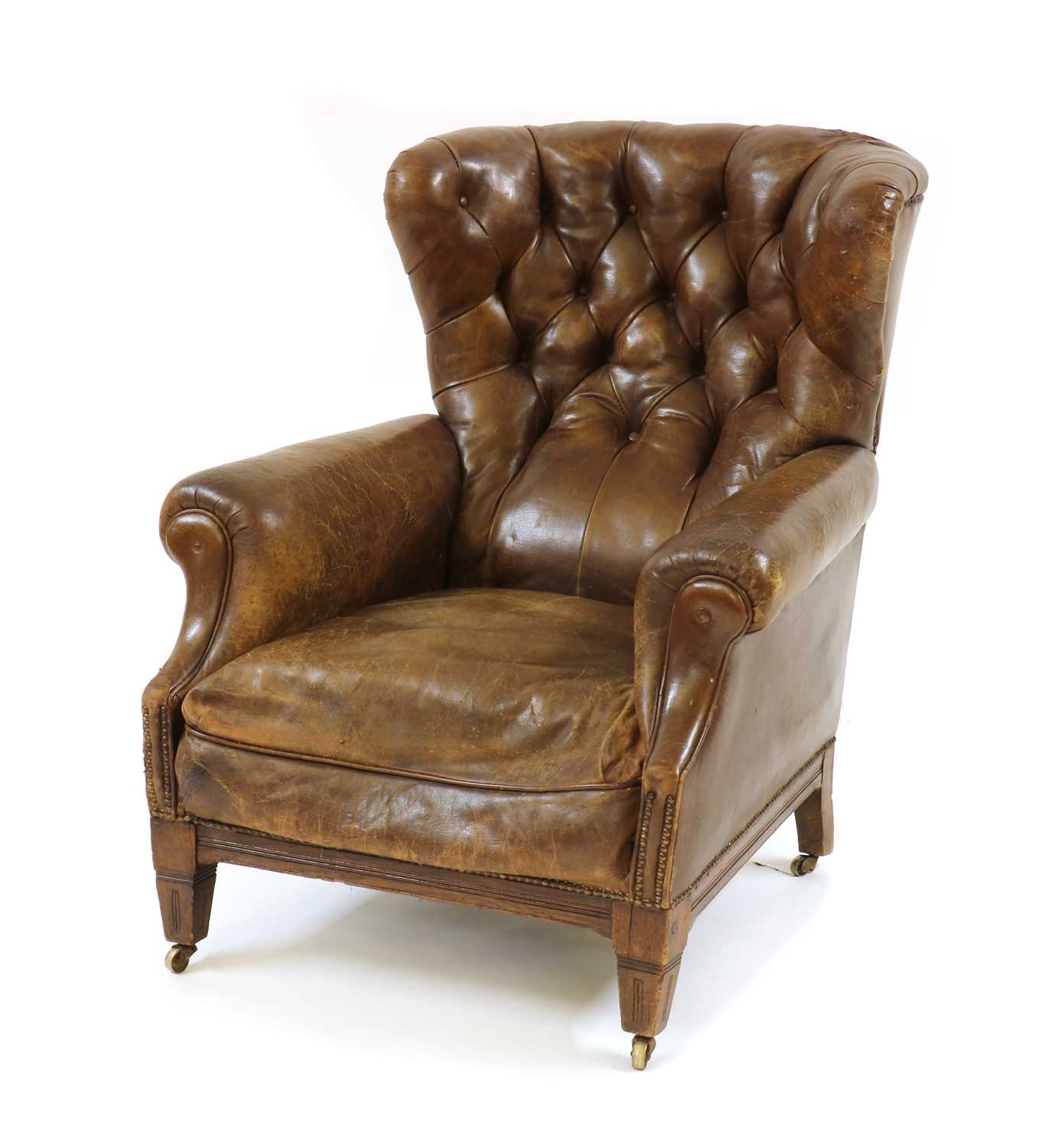 Lot 521 - A brown leather library armchair,
