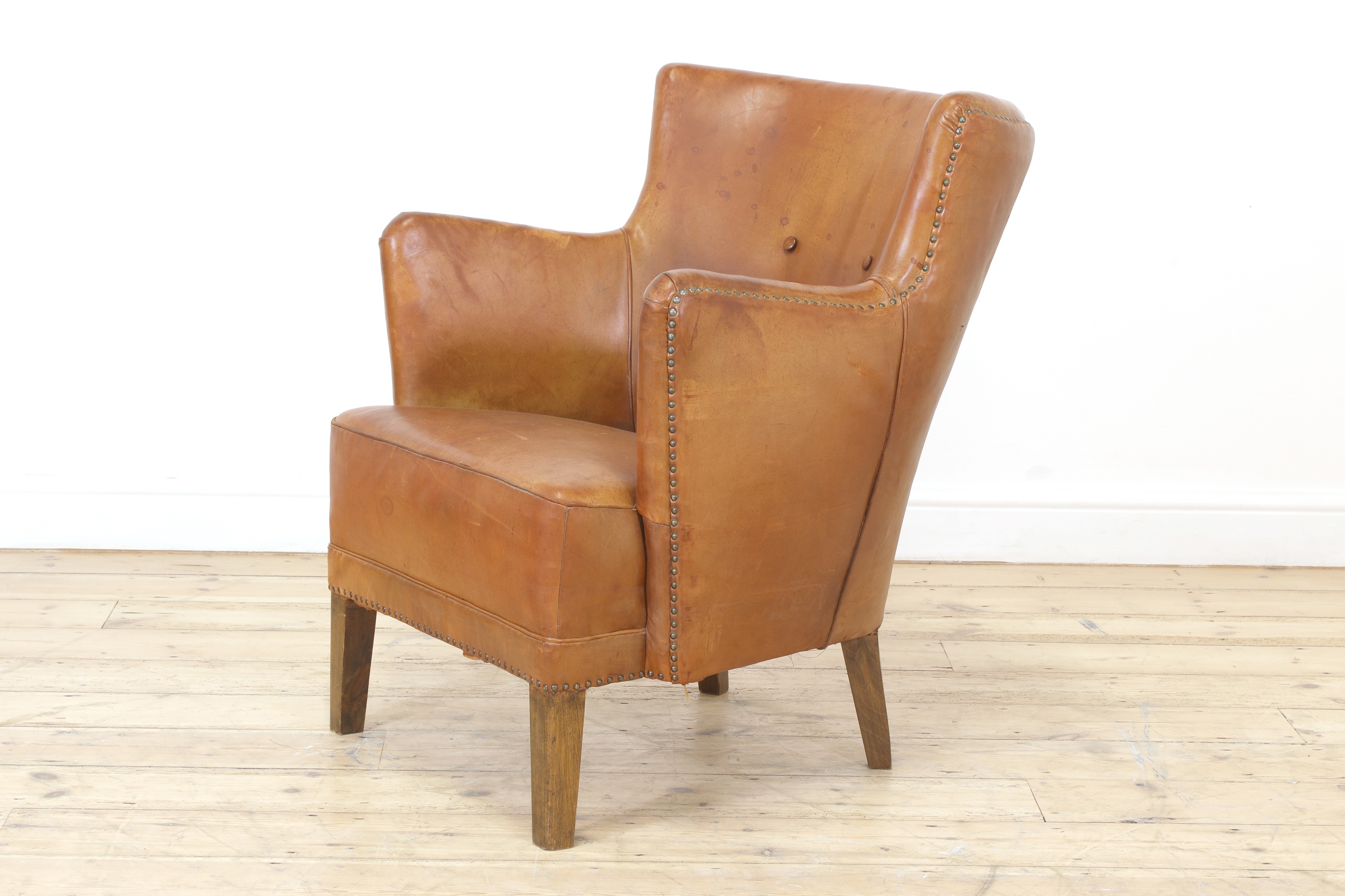 Lot 158 - A tan leather armchair,