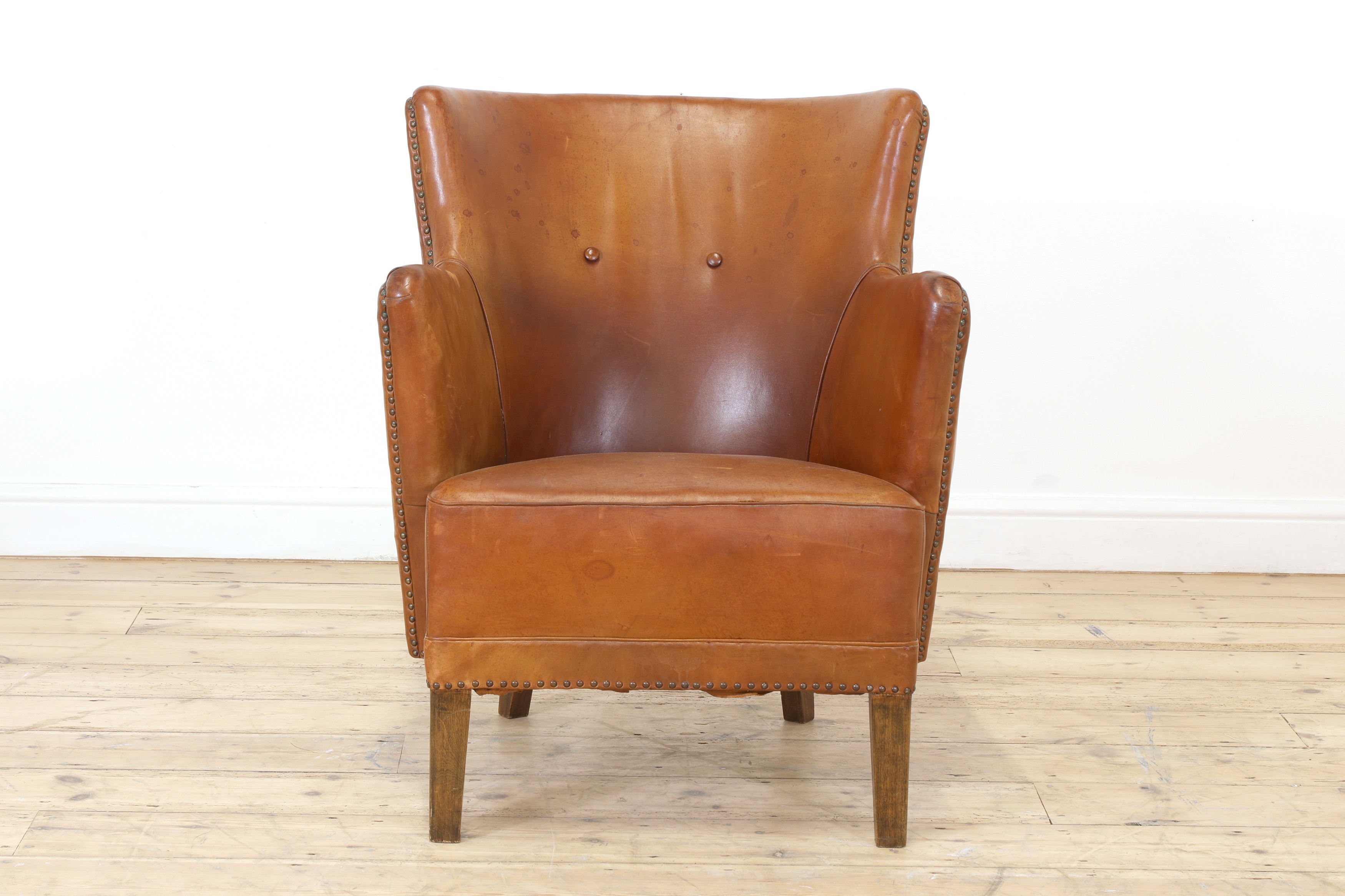 Lot 158 - A tan leather armchair,