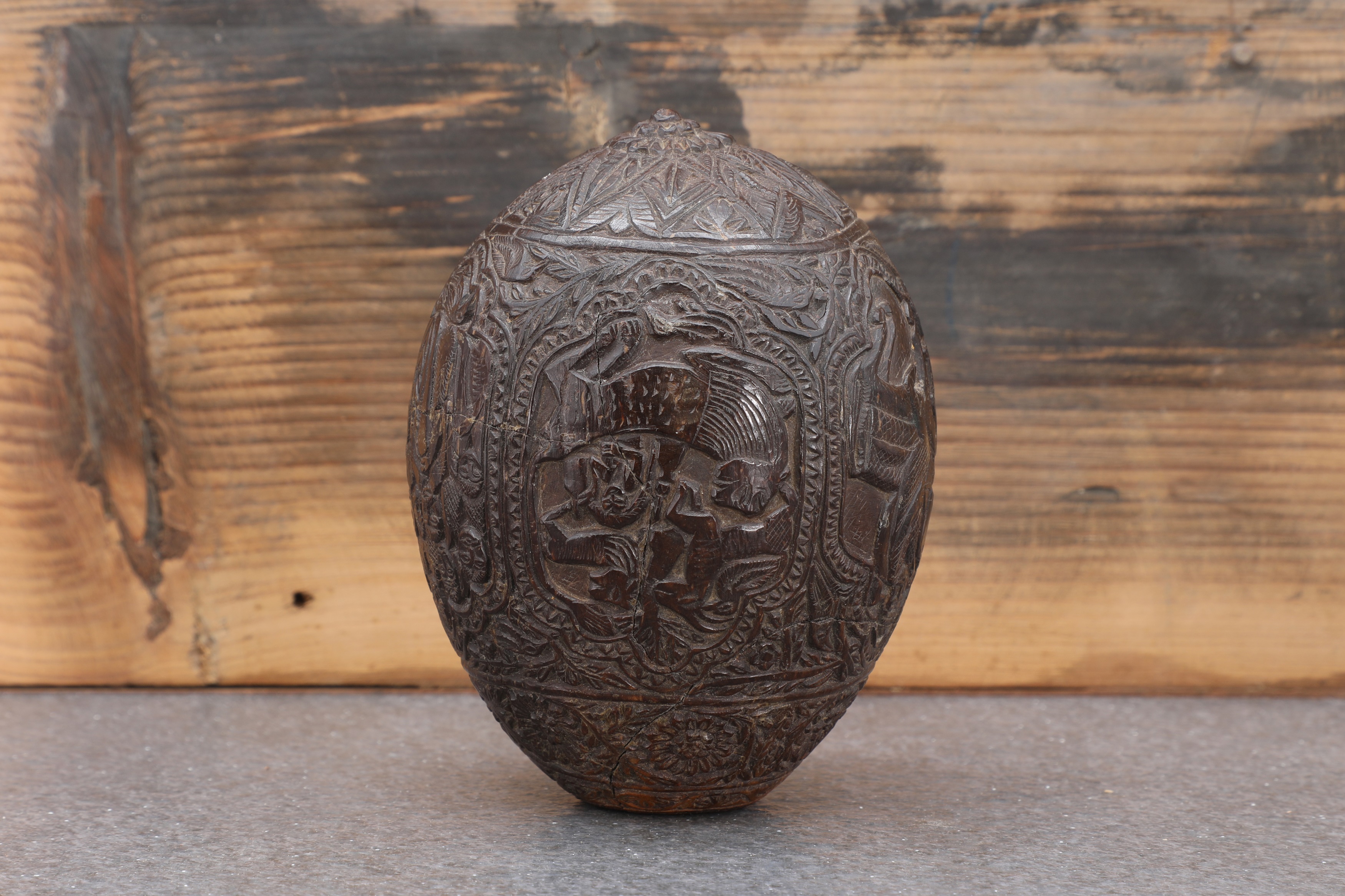 Lot 200 - A carved 'bugbear' coconut flask,
