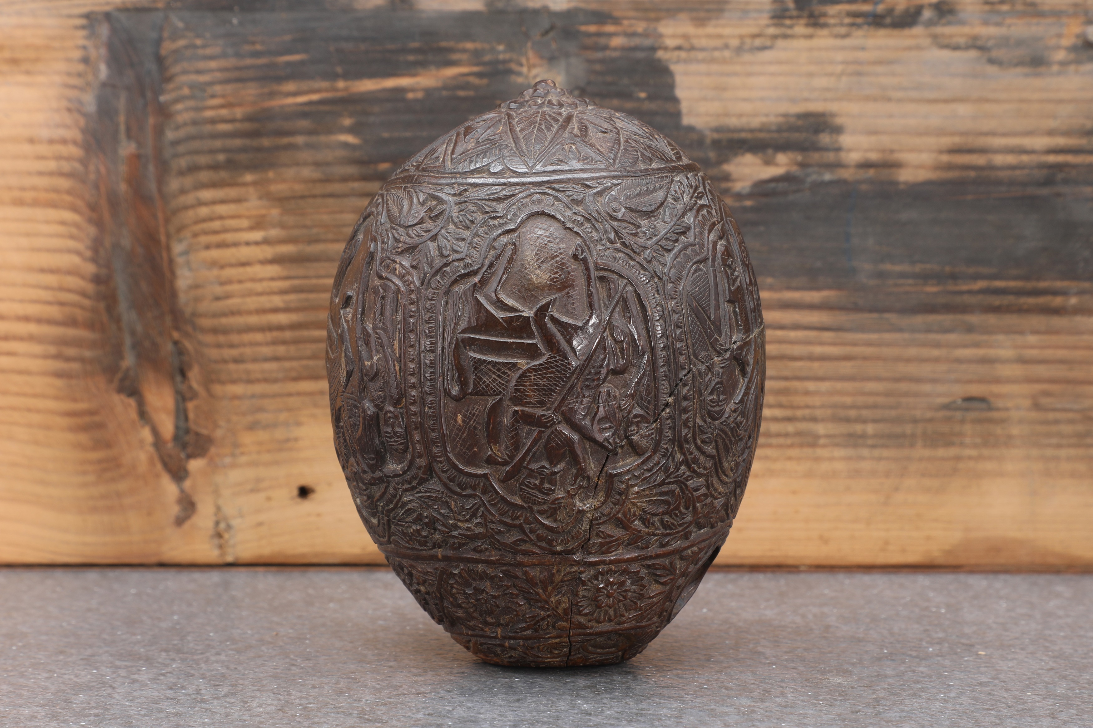 Lot 200 - A carved 'bugbear' coconut flask,