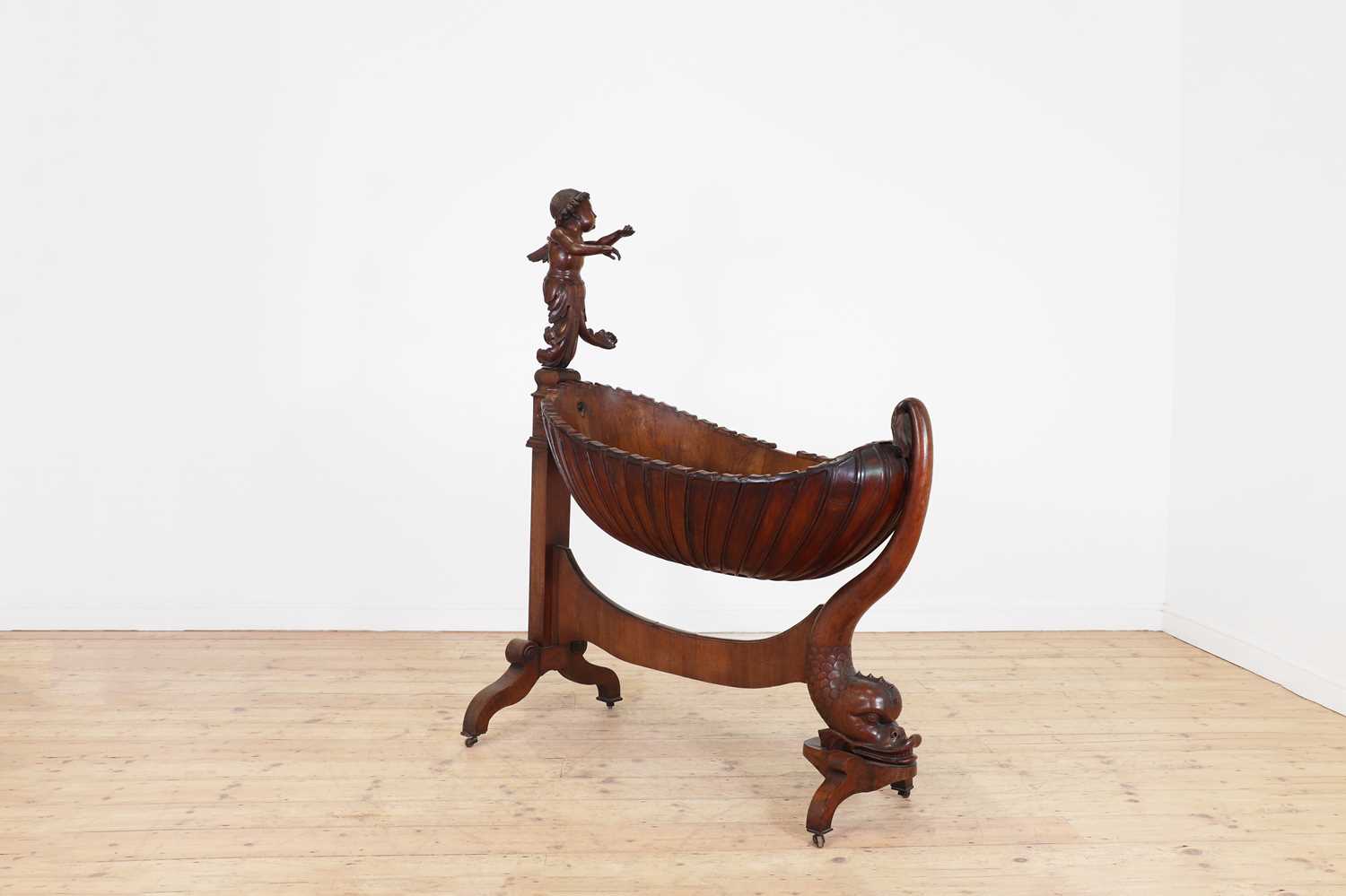 Lot 163 - A rococo carved walnut cradle,