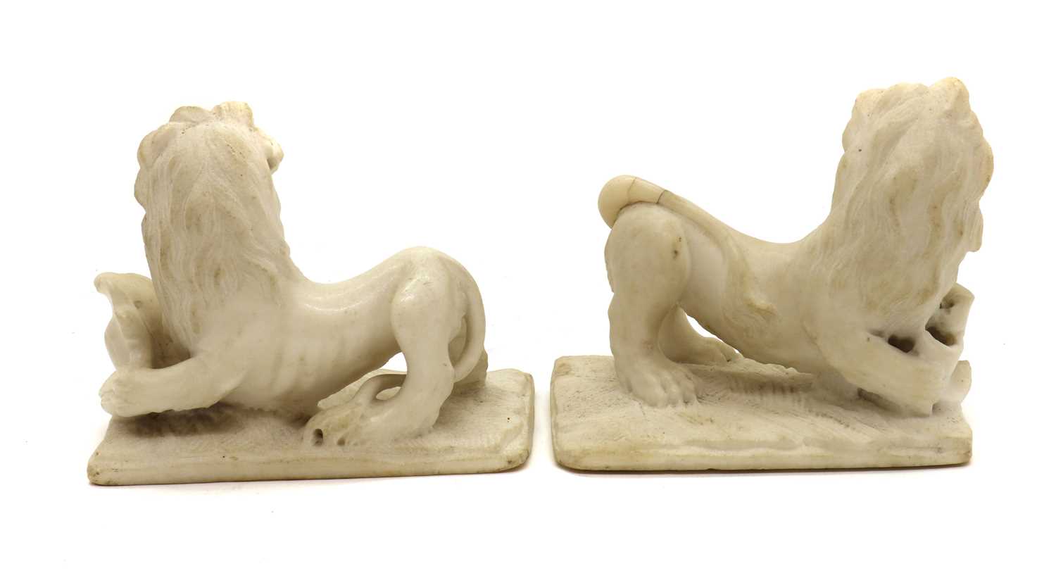 Lot 181 - A pair of heraldic alabaster lions