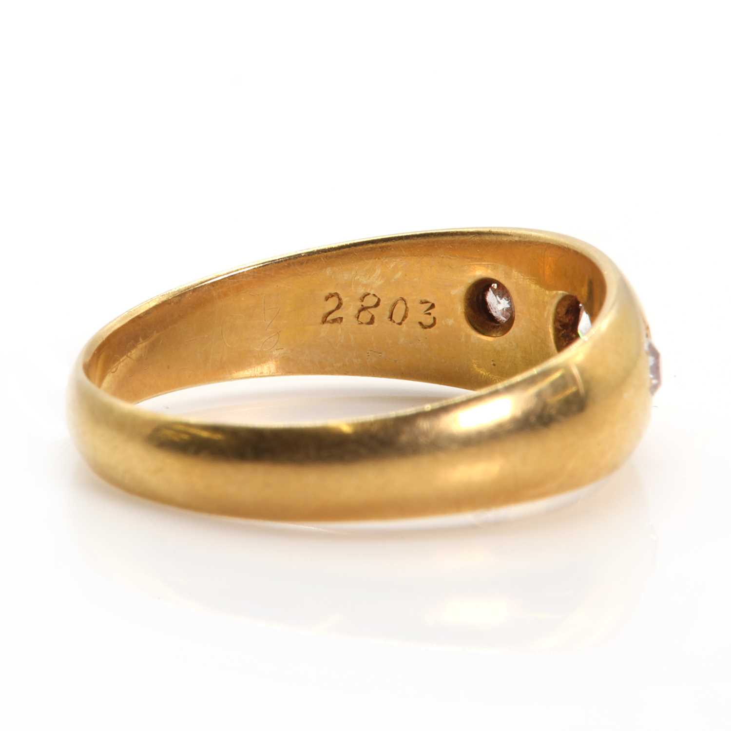 Lot 125 - An 18ct gold three stone diamond gypsy ring,