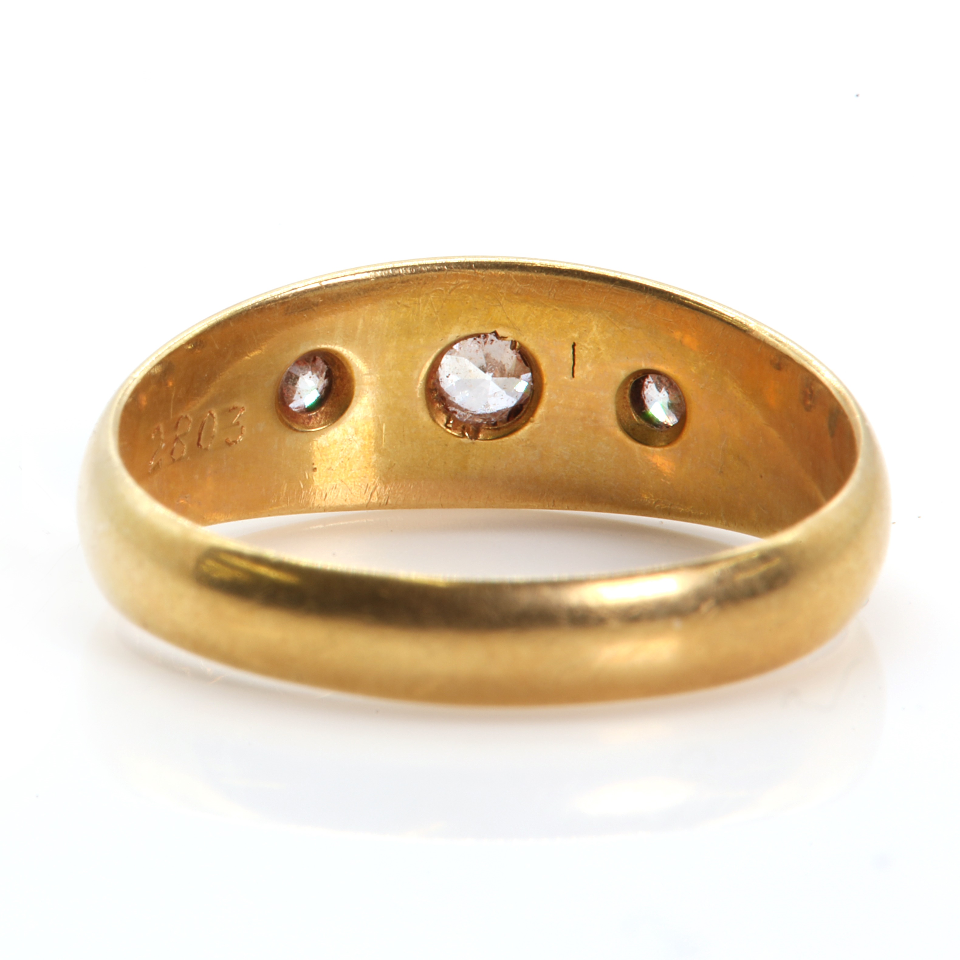 Lot 125 - An 18ct gold three stone diamond gypsy ring,