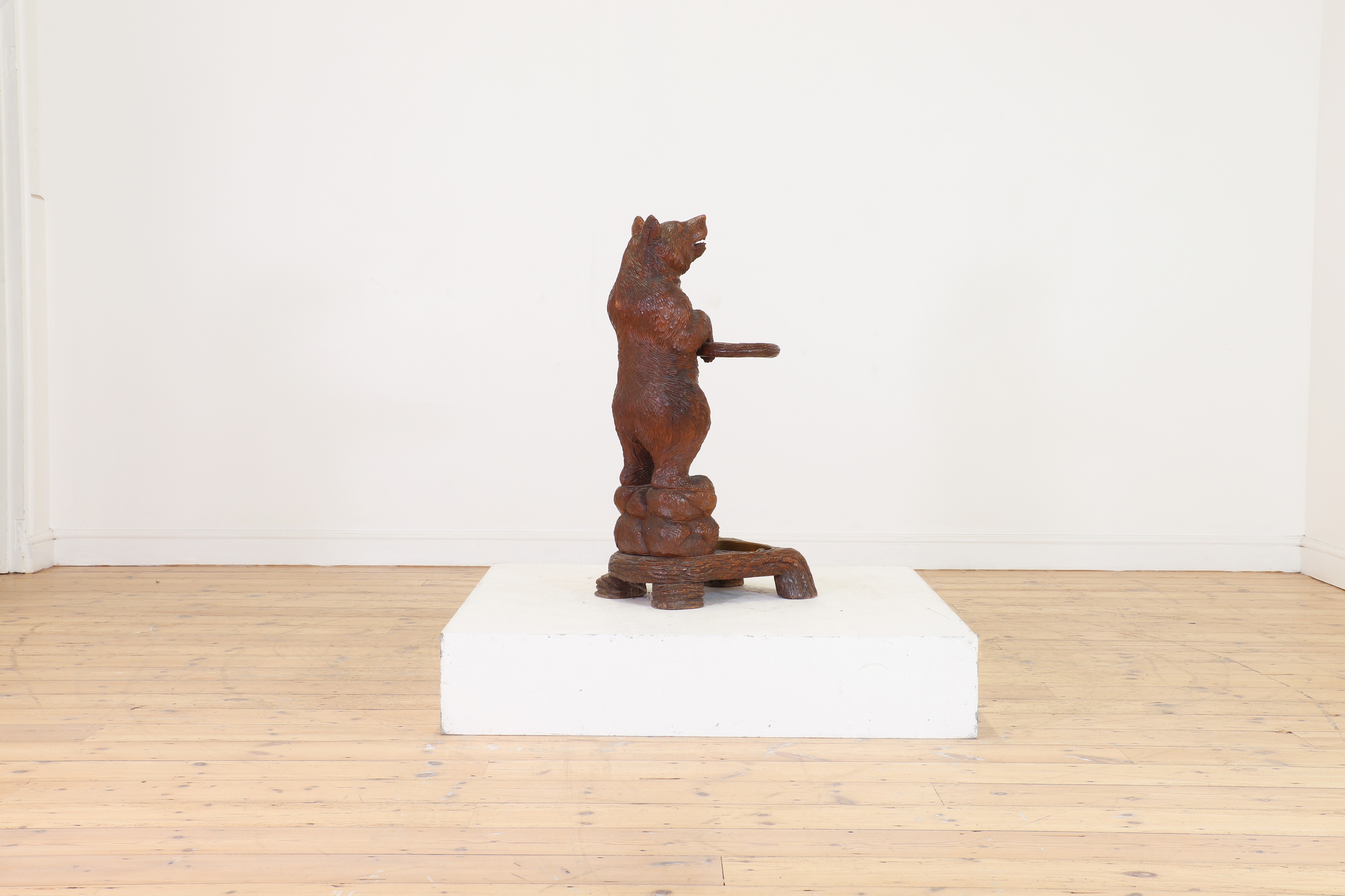 Lot 636 - A Black Forest carved wood stick stand,