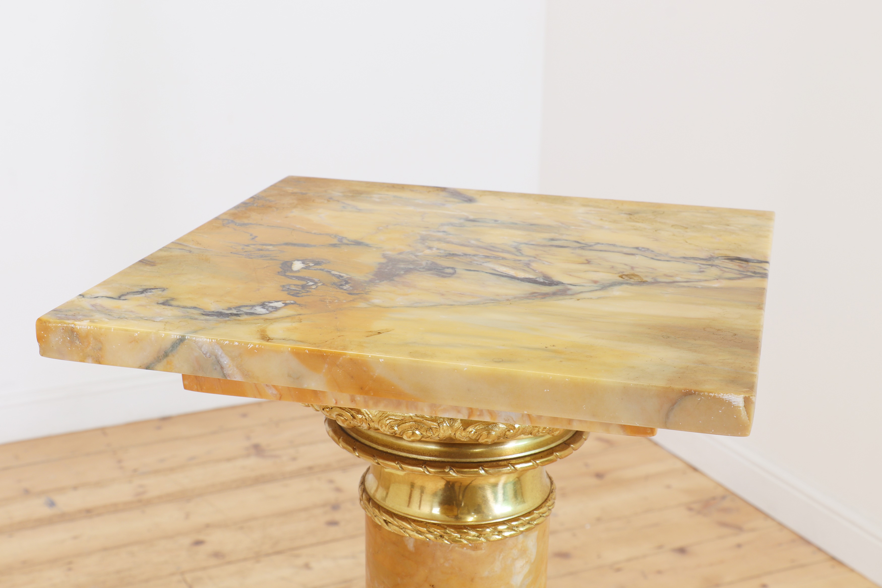 Lot 638 - A pair of giallo antico marble pedestals,