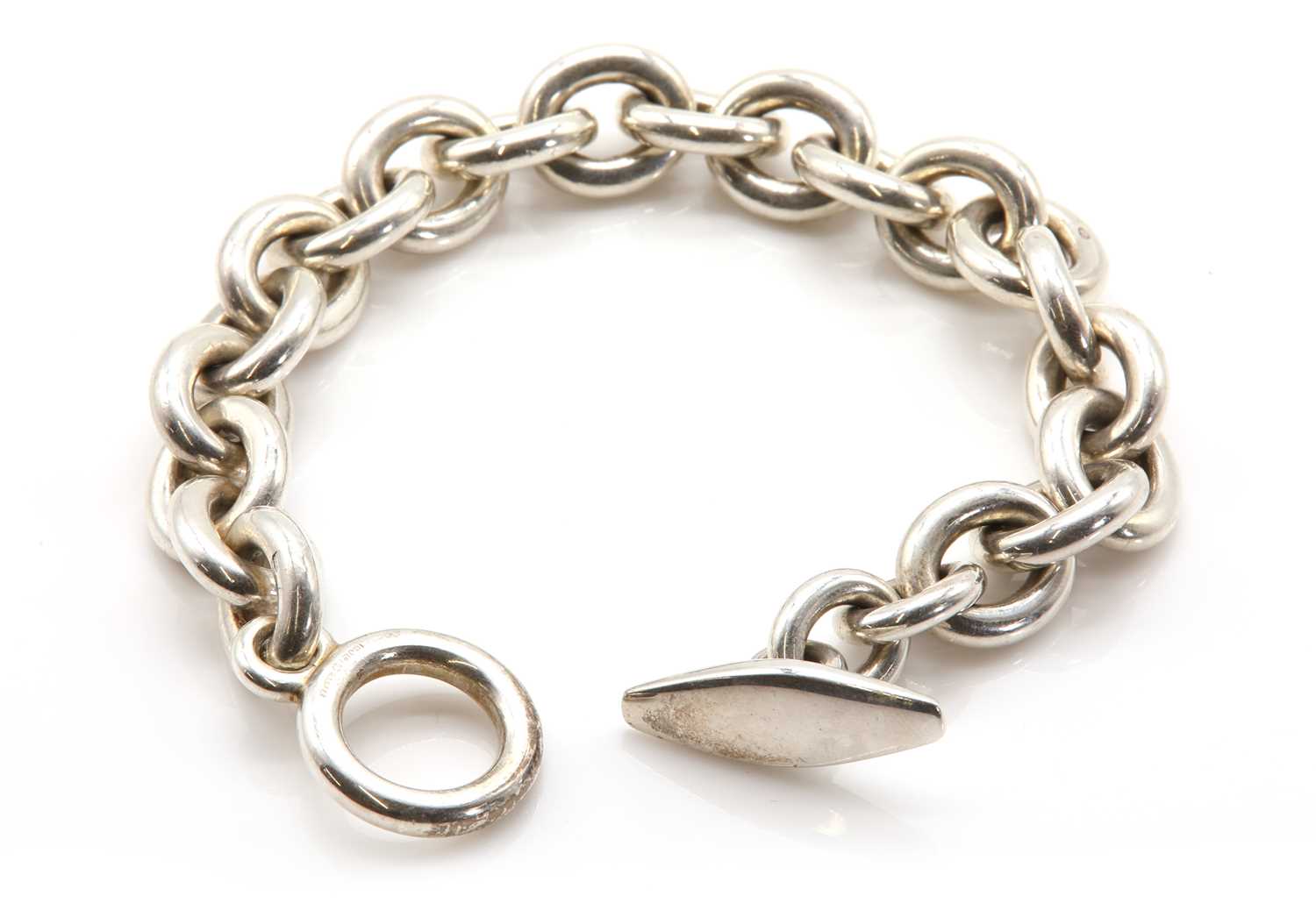 Lot 442 - A sterling silver trace chain bracelet, by
