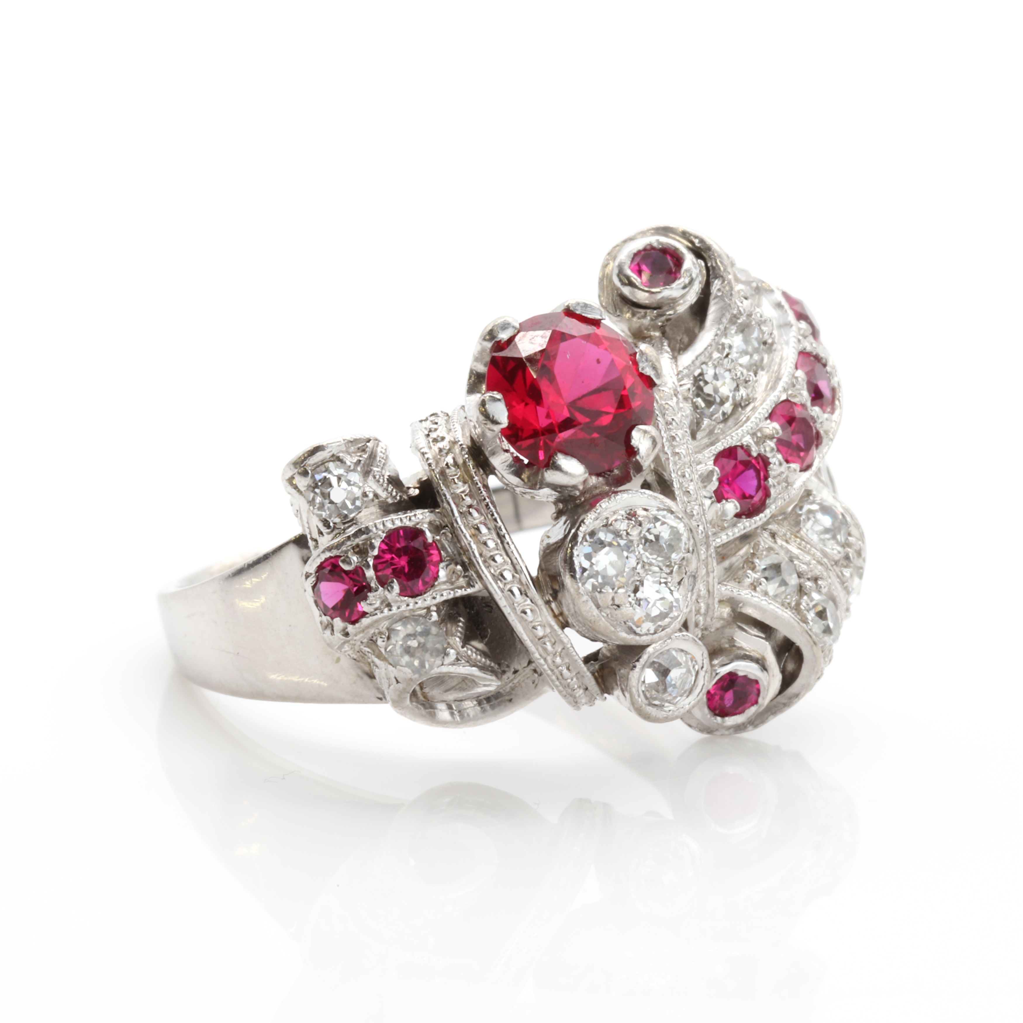 Lot 166 - An abstract diamond and synthetic ruby ring,