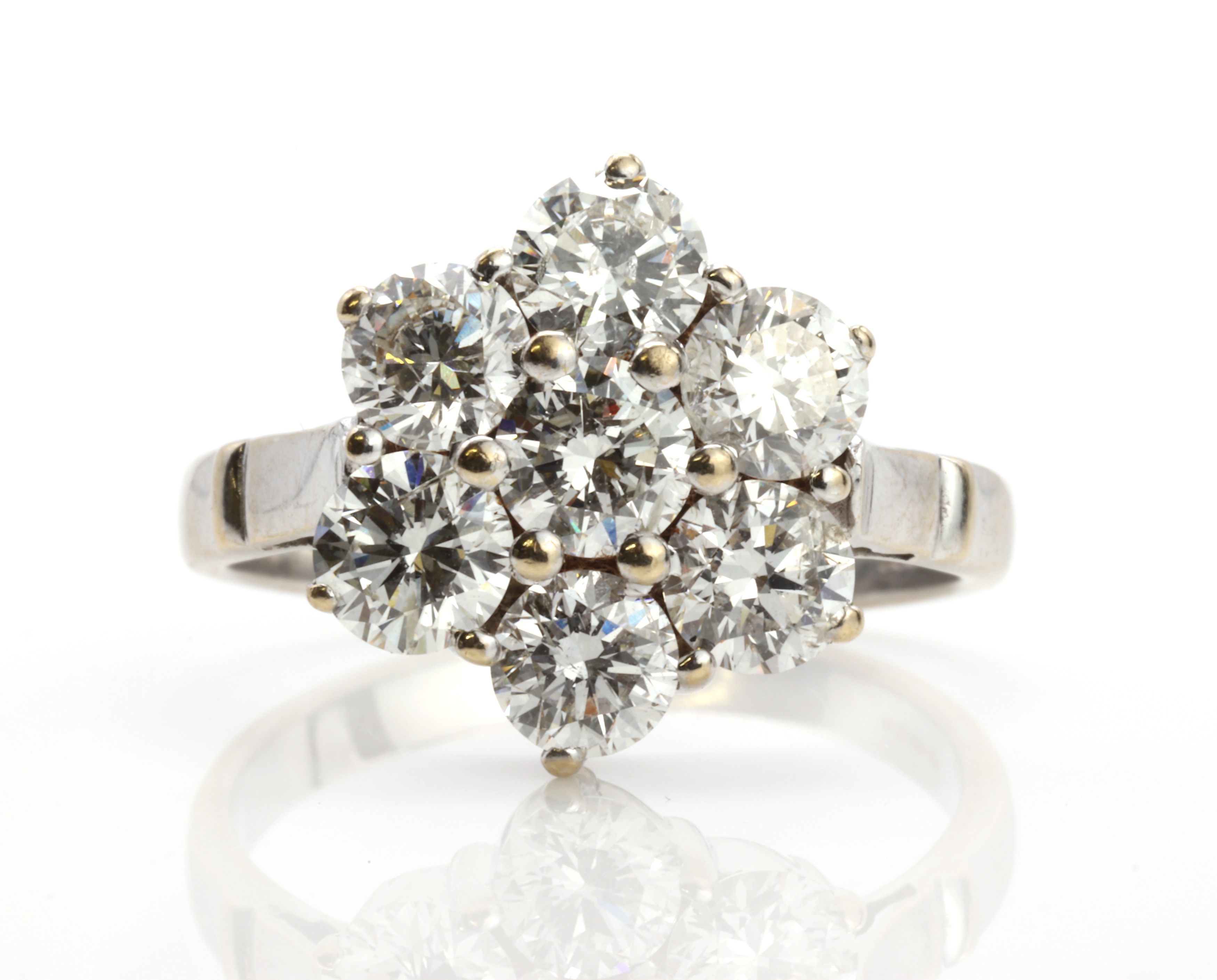 Lot 367 - A white gold diamond flowerhead ring,