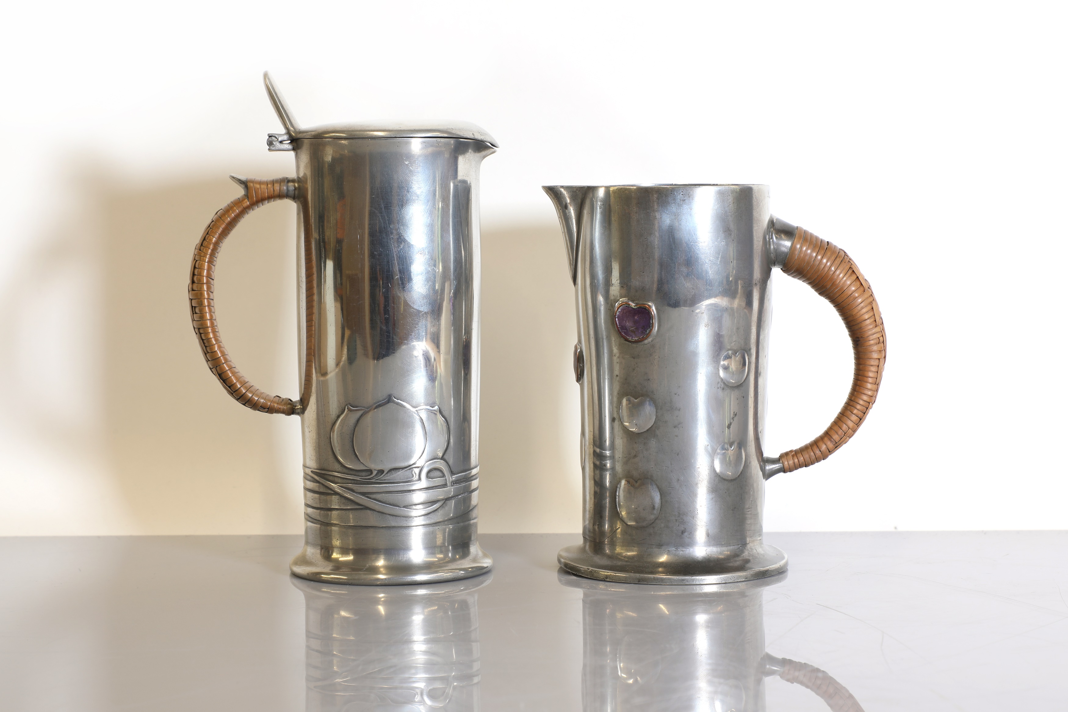 Lot 74 - A Tudric pewter lidded jug,