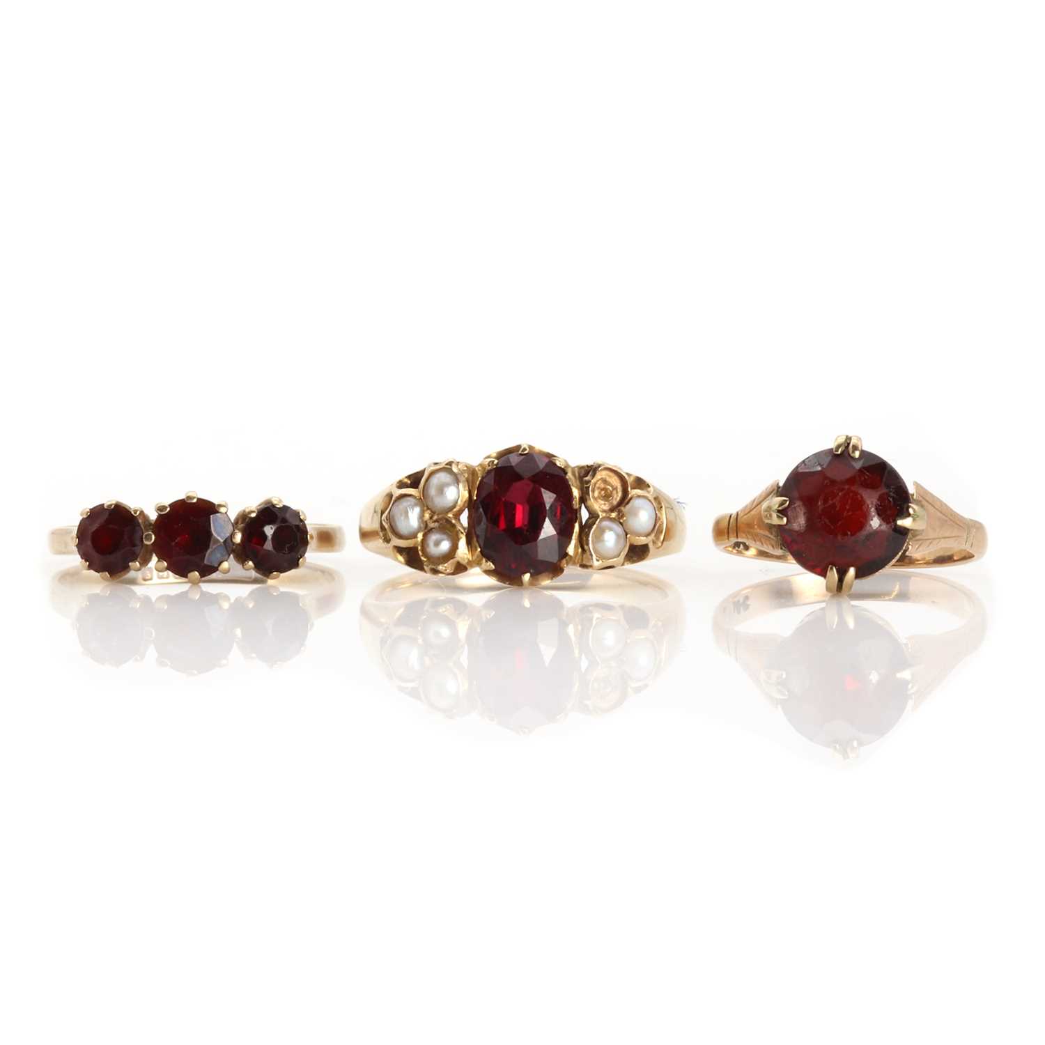 Lot 1285 - Three gold garnet set rings,