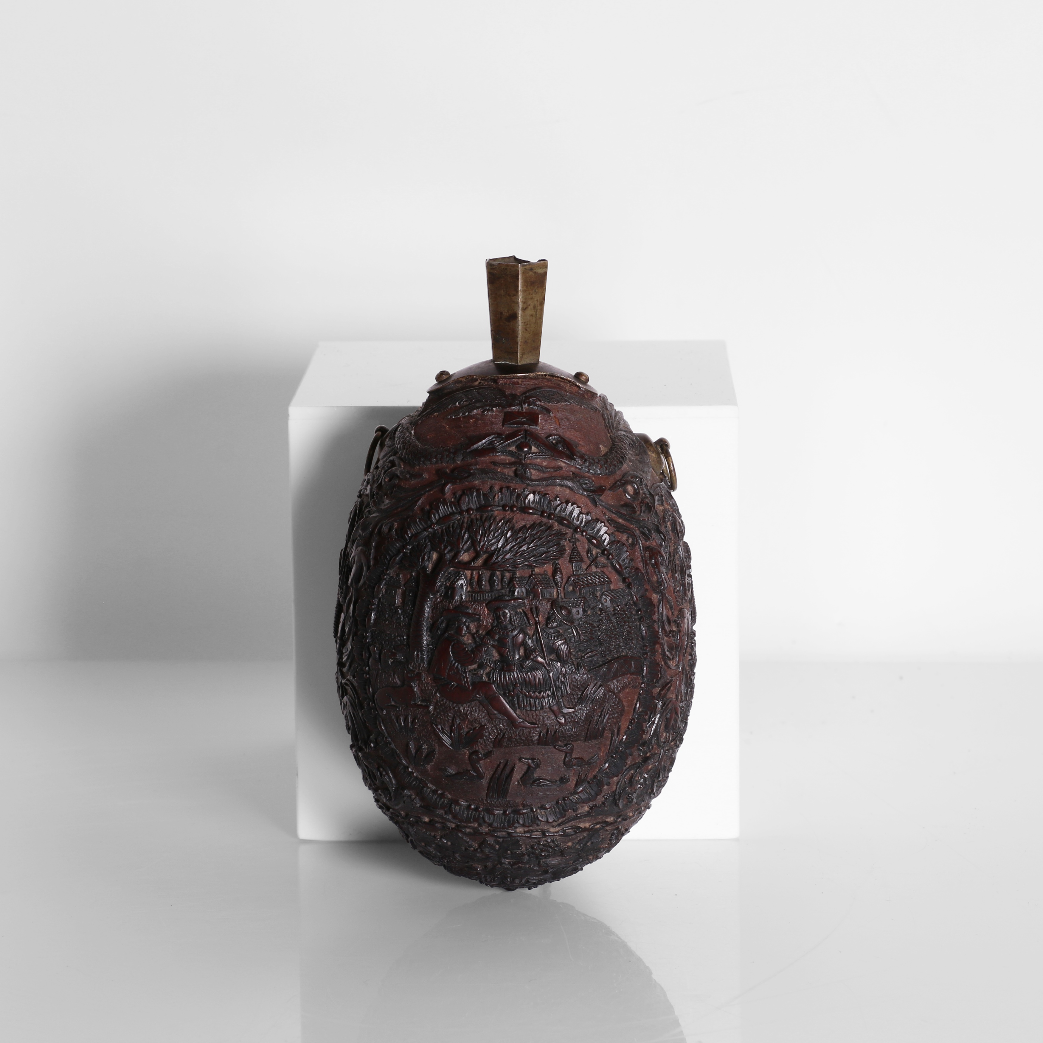 Lot 2 - A carved coconut 'bugbear' flask,