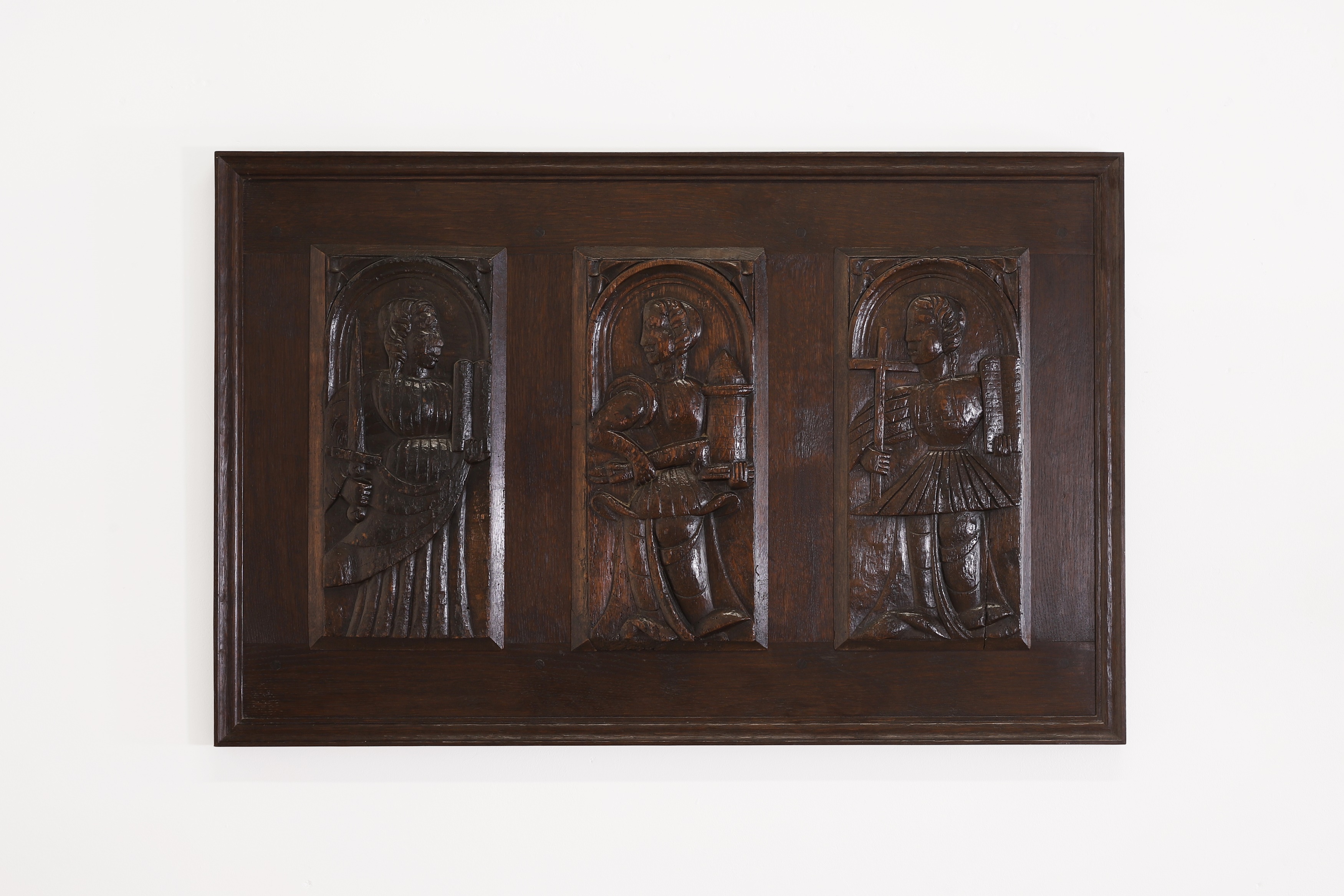Lot 353 - Three carved oak panels depicting saints,