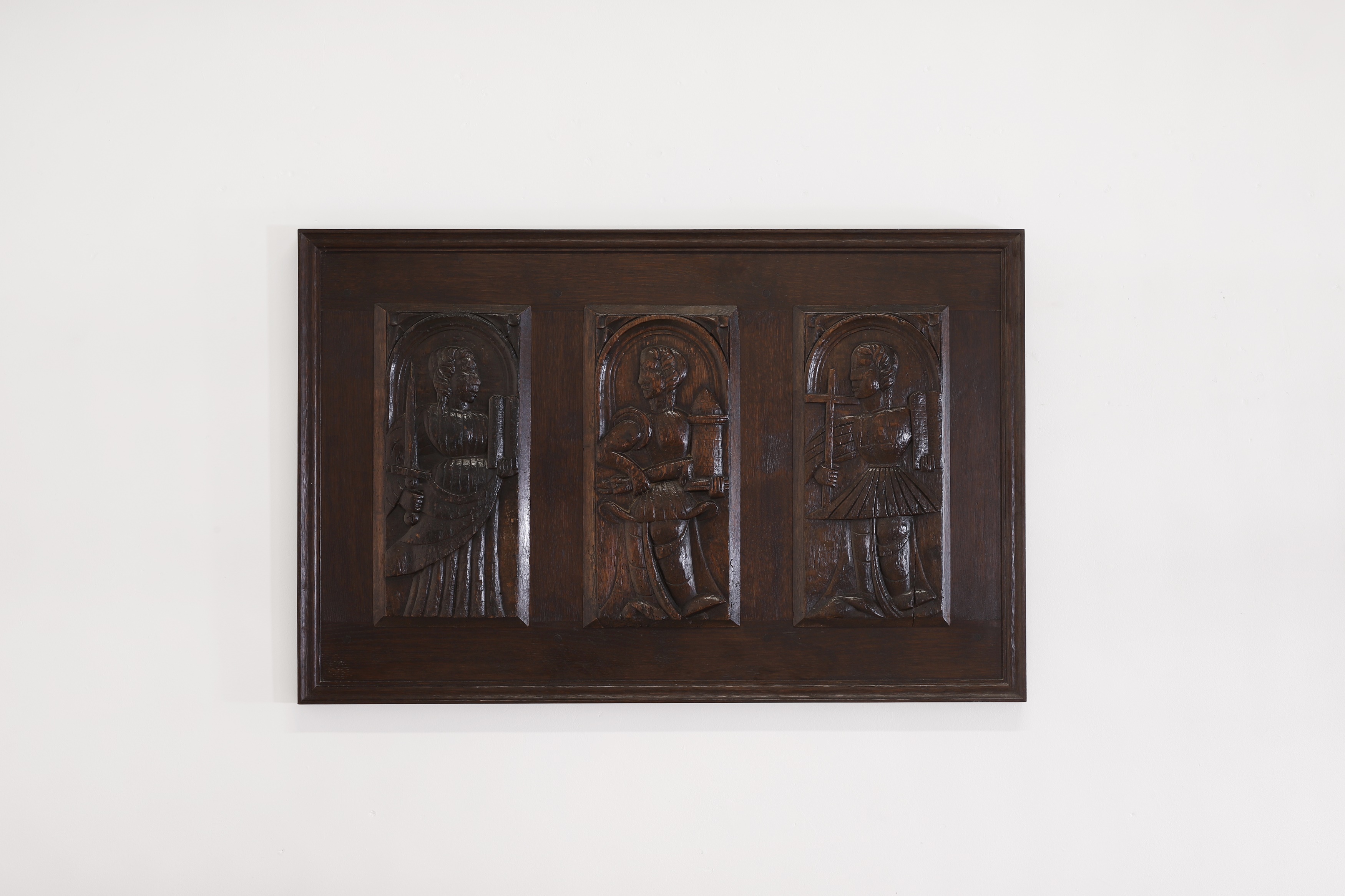 Lot 353 - Three carved oak panels depicting saints,