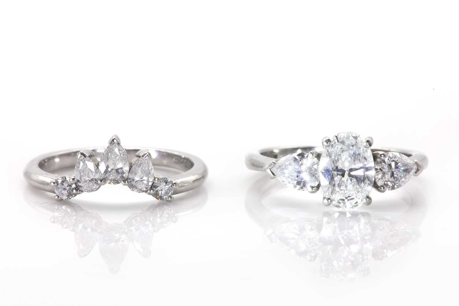 Lot 135 - A platinum and diamond three stone ring and