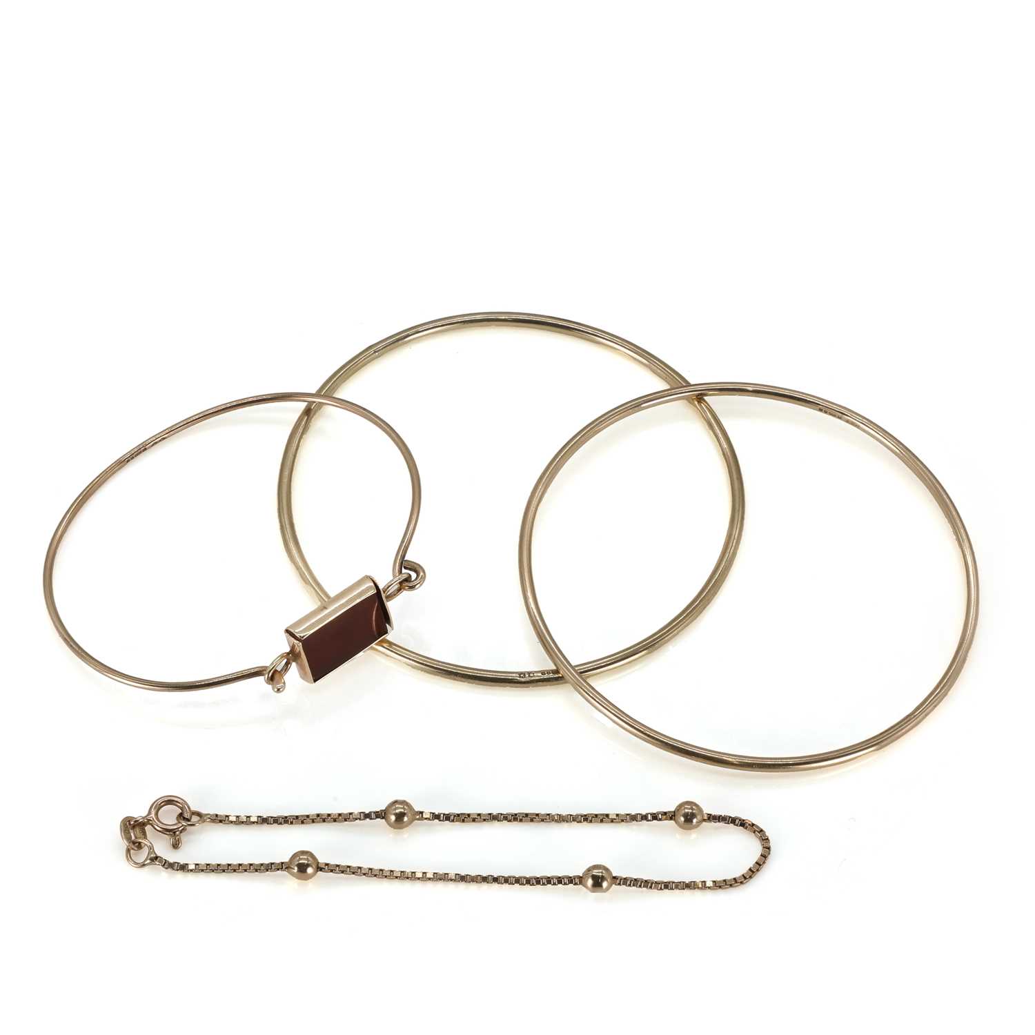 Lot 210 - Three 9ct gold bangles and one 9ct gold