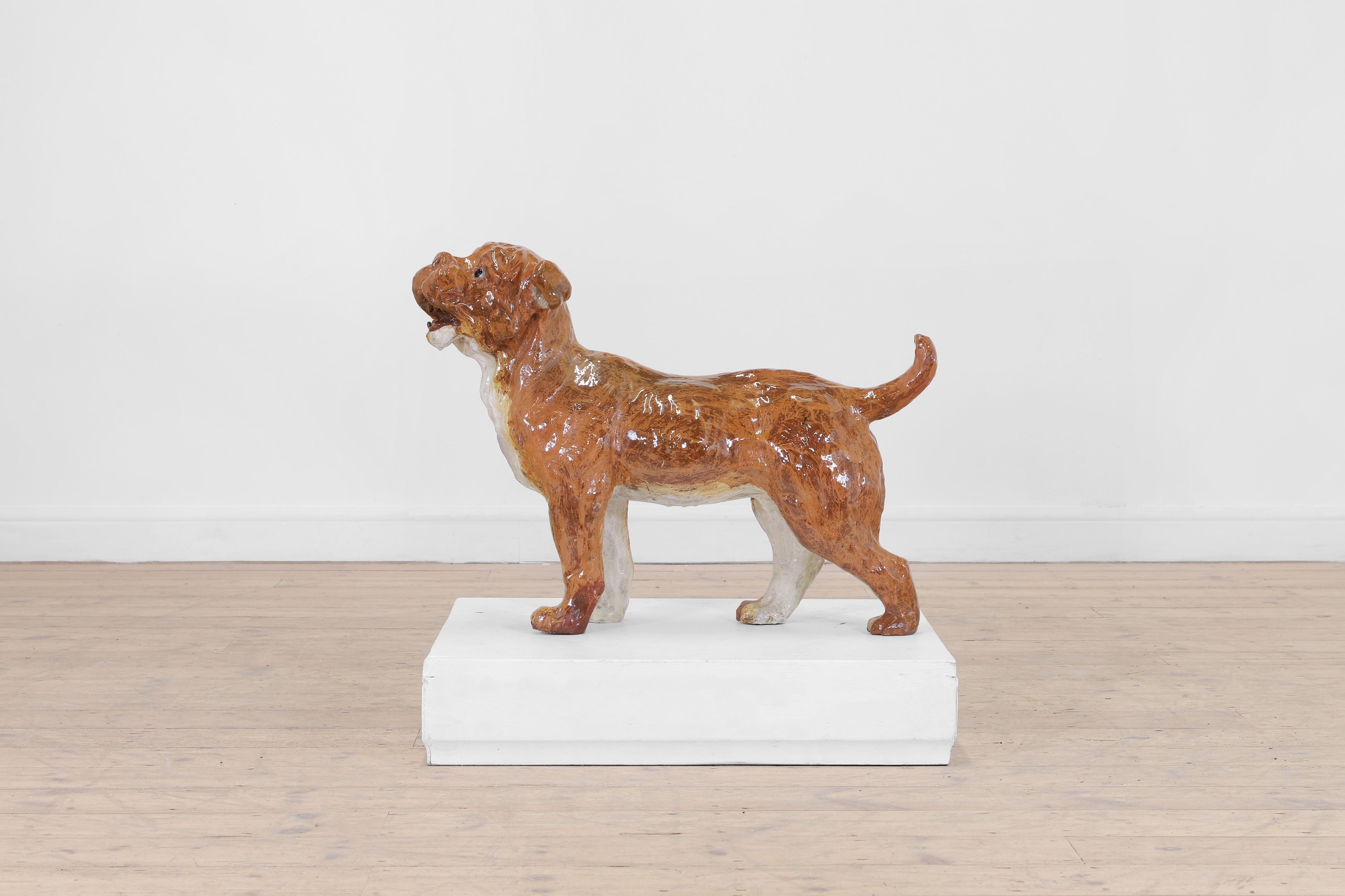 Lot 407 - A glazed pottery boxer dog,