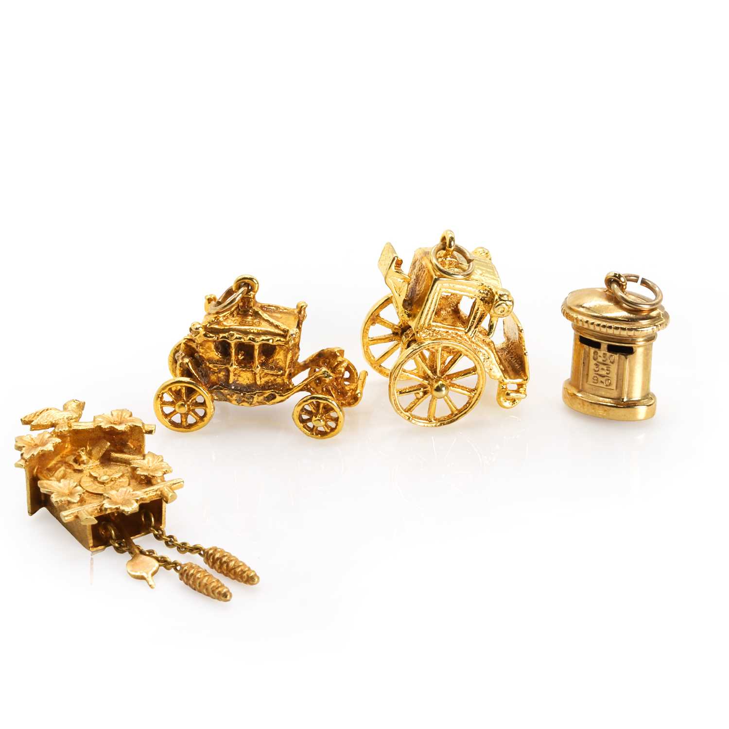 Lot 255 - A group of four gold charms,