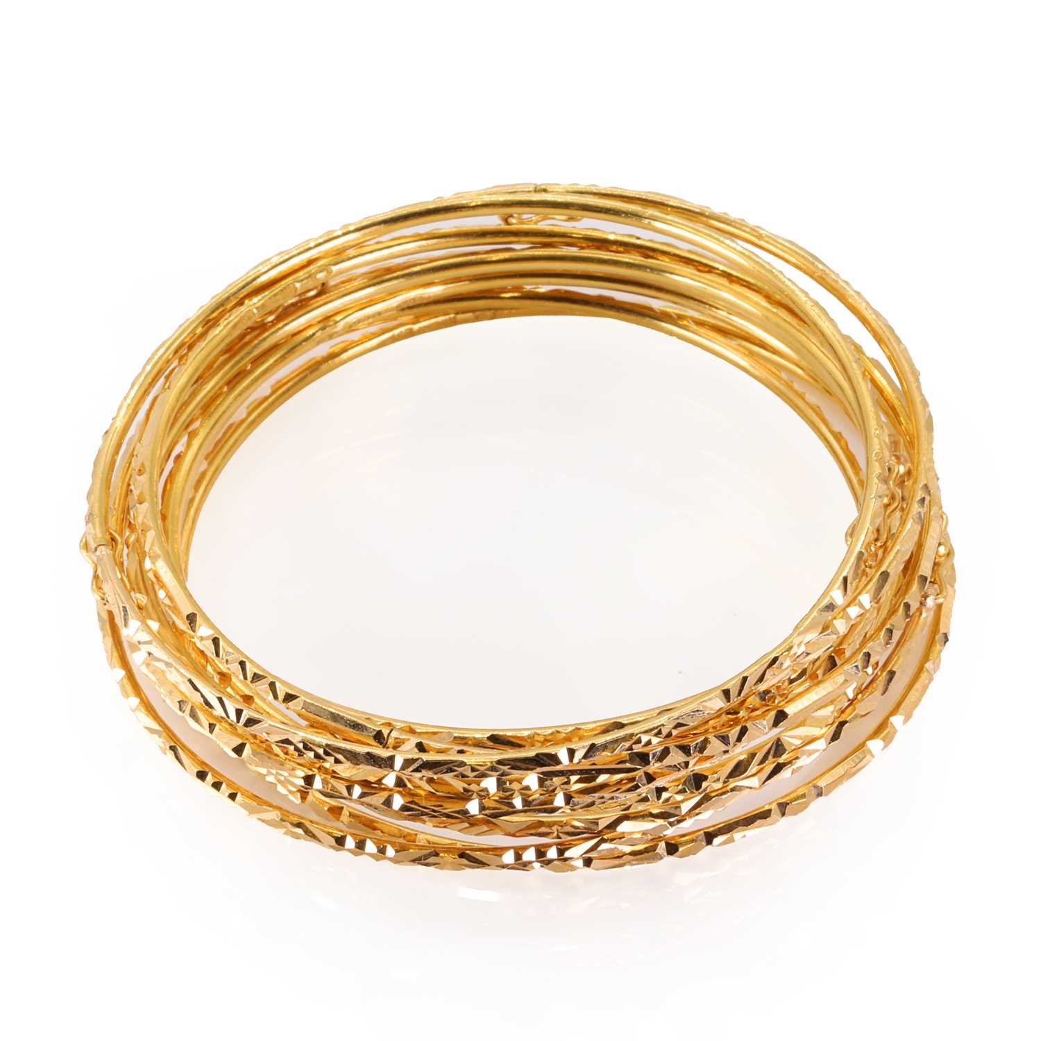 Lot 252 - A group of nine plain gold bangles,