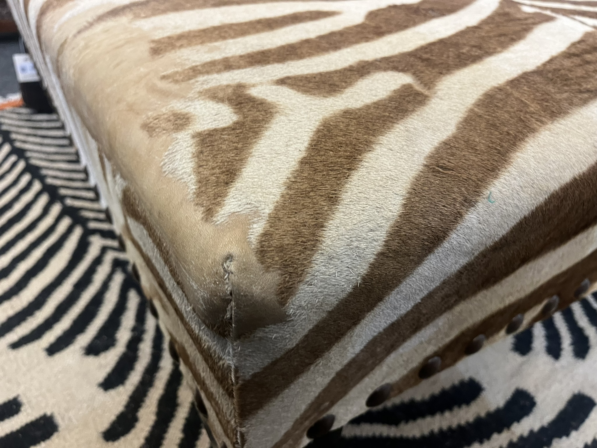 Lot 63 - A stained wood and zebra skin stool,