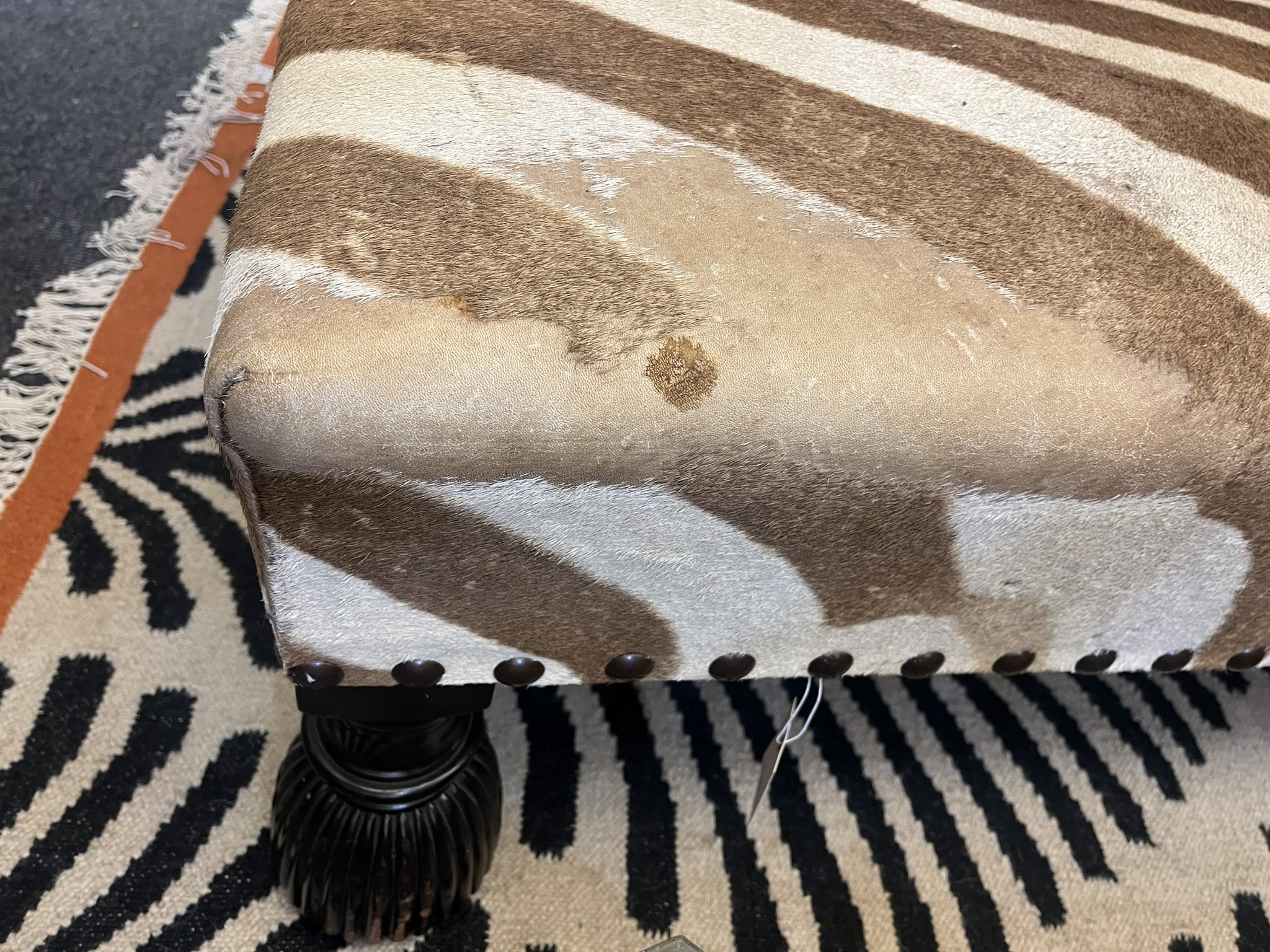 Lot 63 - A stained wood and zebra skin stool,