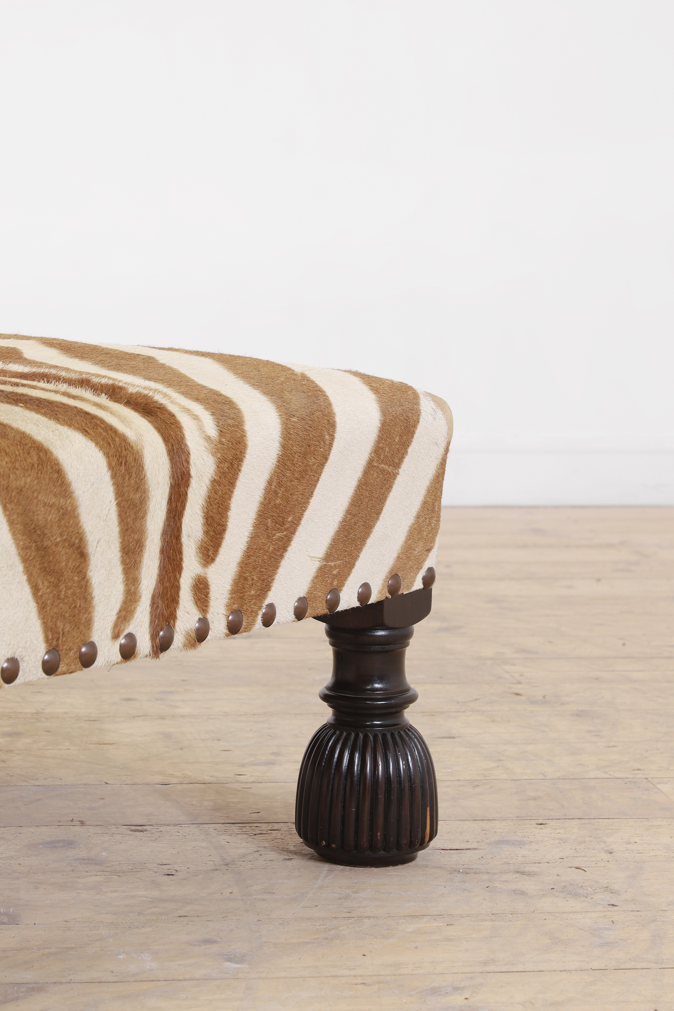 Lot 63 - A stained wood and zebra skin stool,