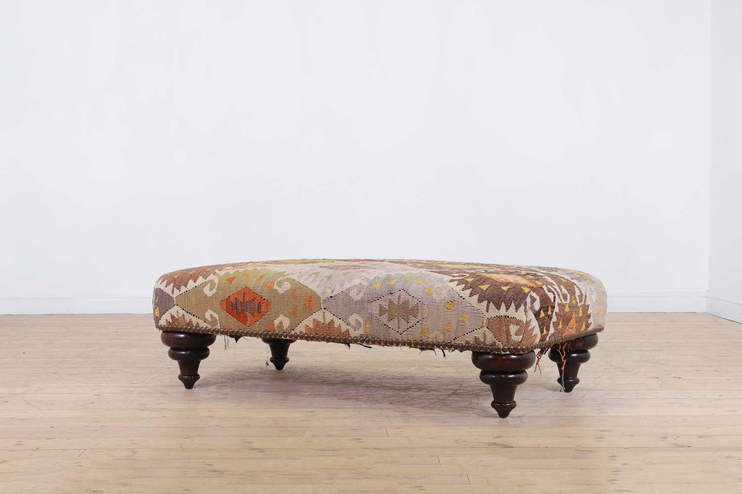 Lot 528 - A large kilim-upholstered footstool by